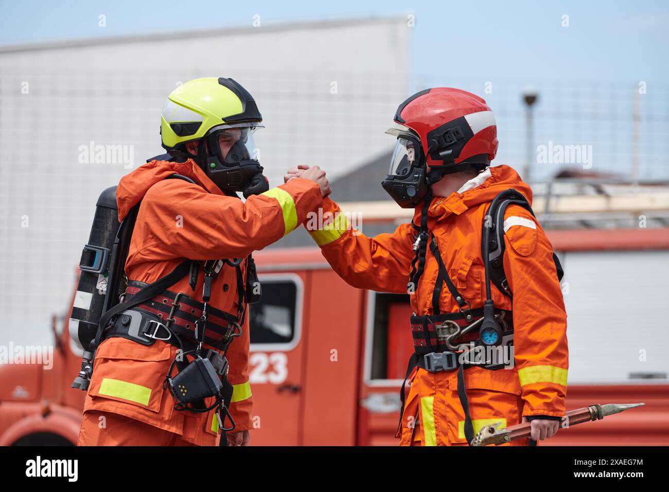 A unified team of firefighters, adorned in their uniforms, engages in a ...