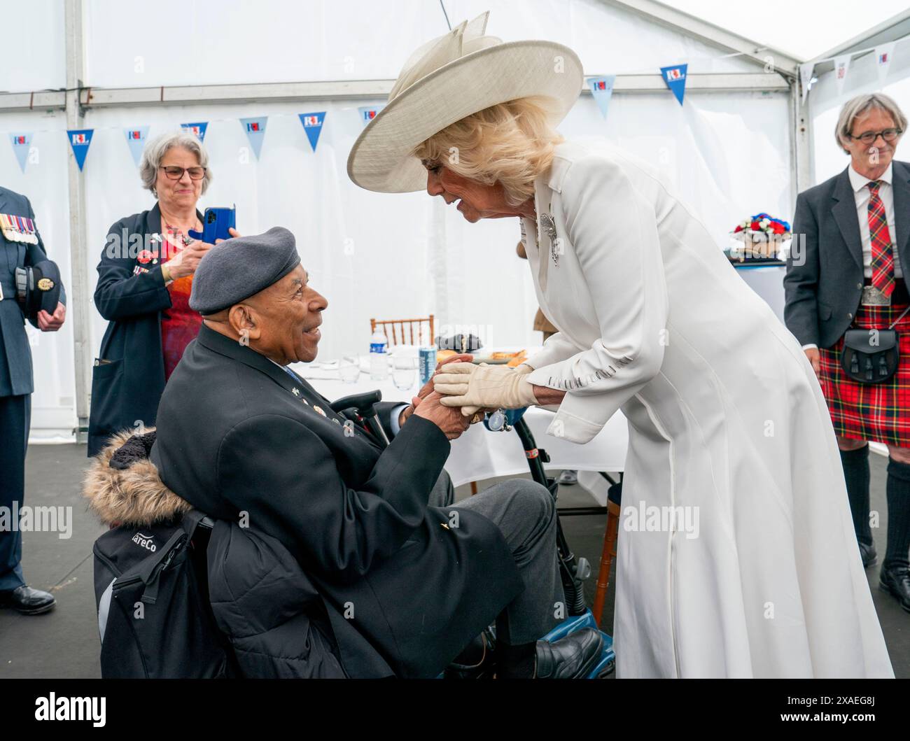 Queen Camilla speaks with veteran Gilbert Clarke, 98, during a lunch ...