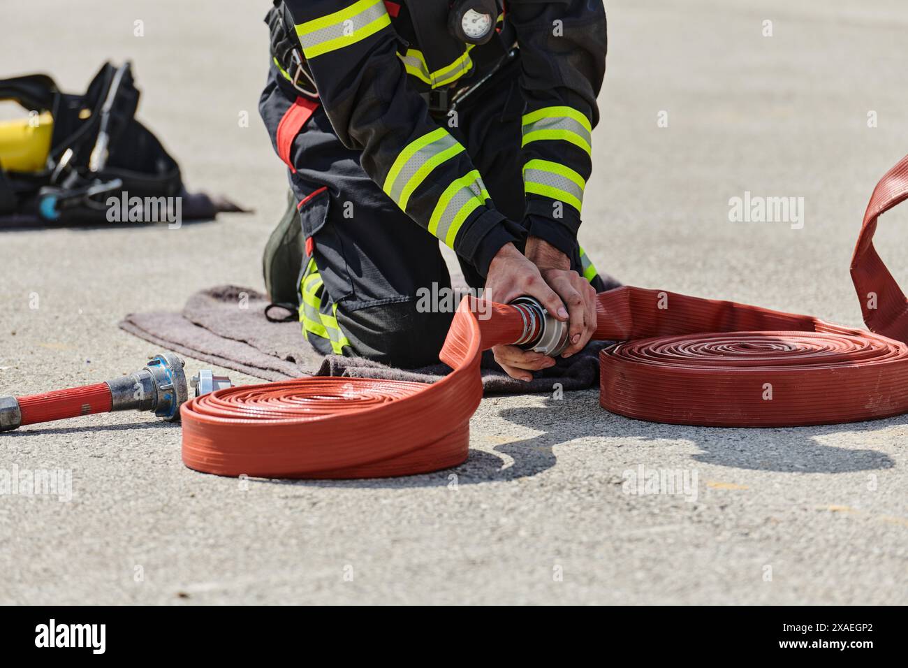 A firefighter dons the essential components of their professional gear ...