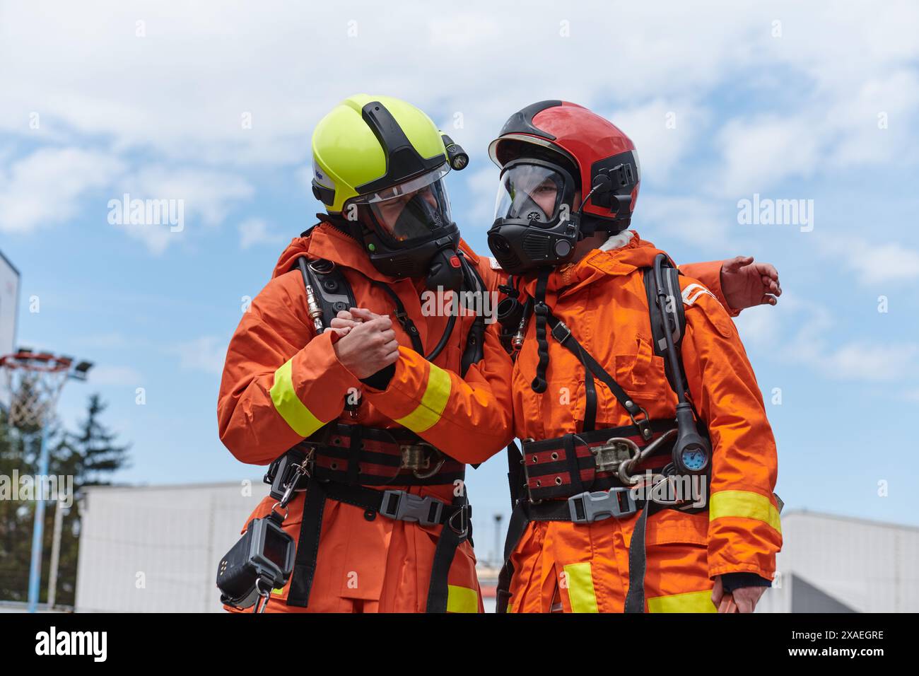 A unified team of firefighters, adorned in their uniforms, engages in a ...