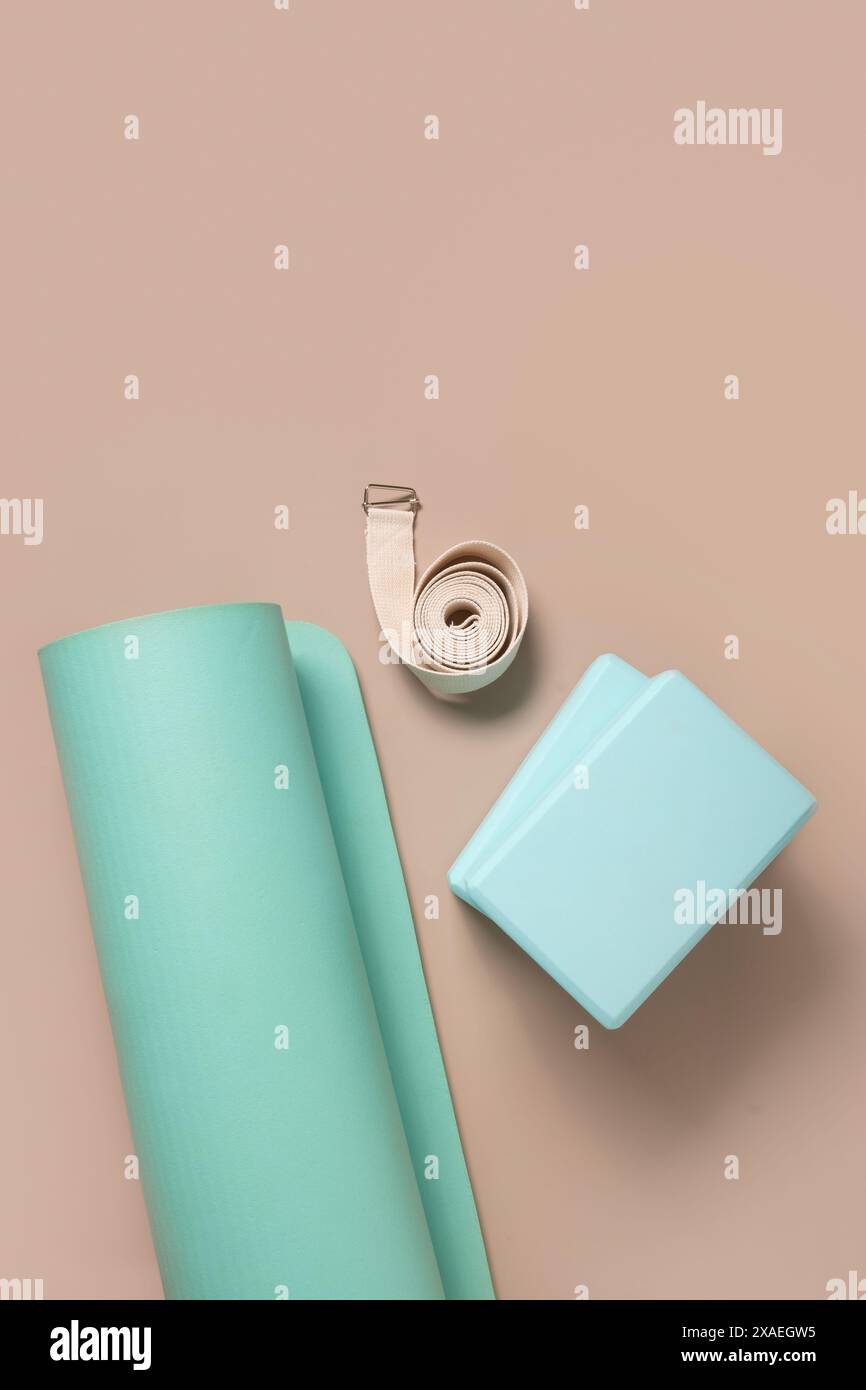 Green yoga blocks and white strap on beige background. Yoga practice ...