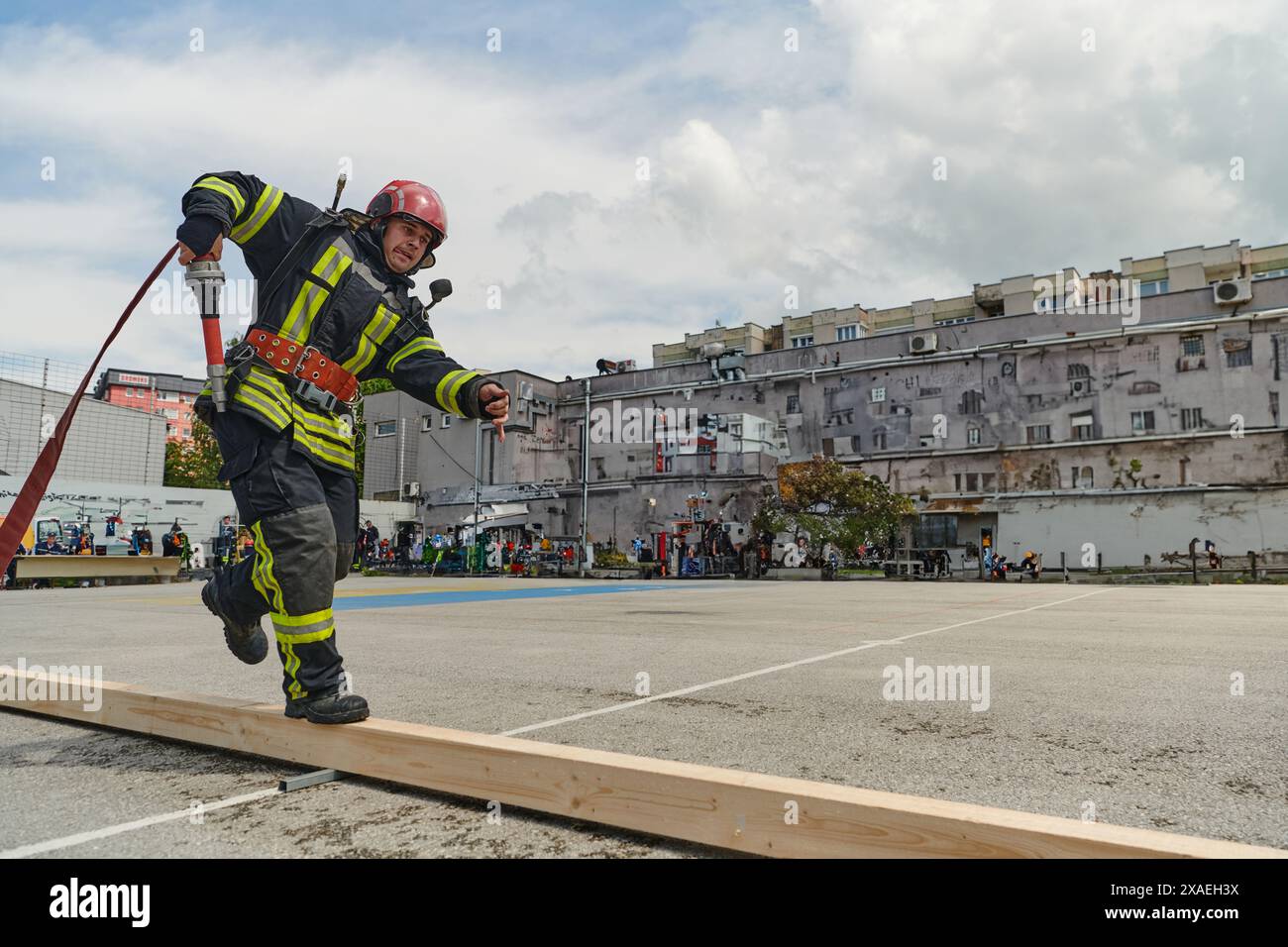 In a dynamic display of synchronized teamwork, firefighters hustle to ...