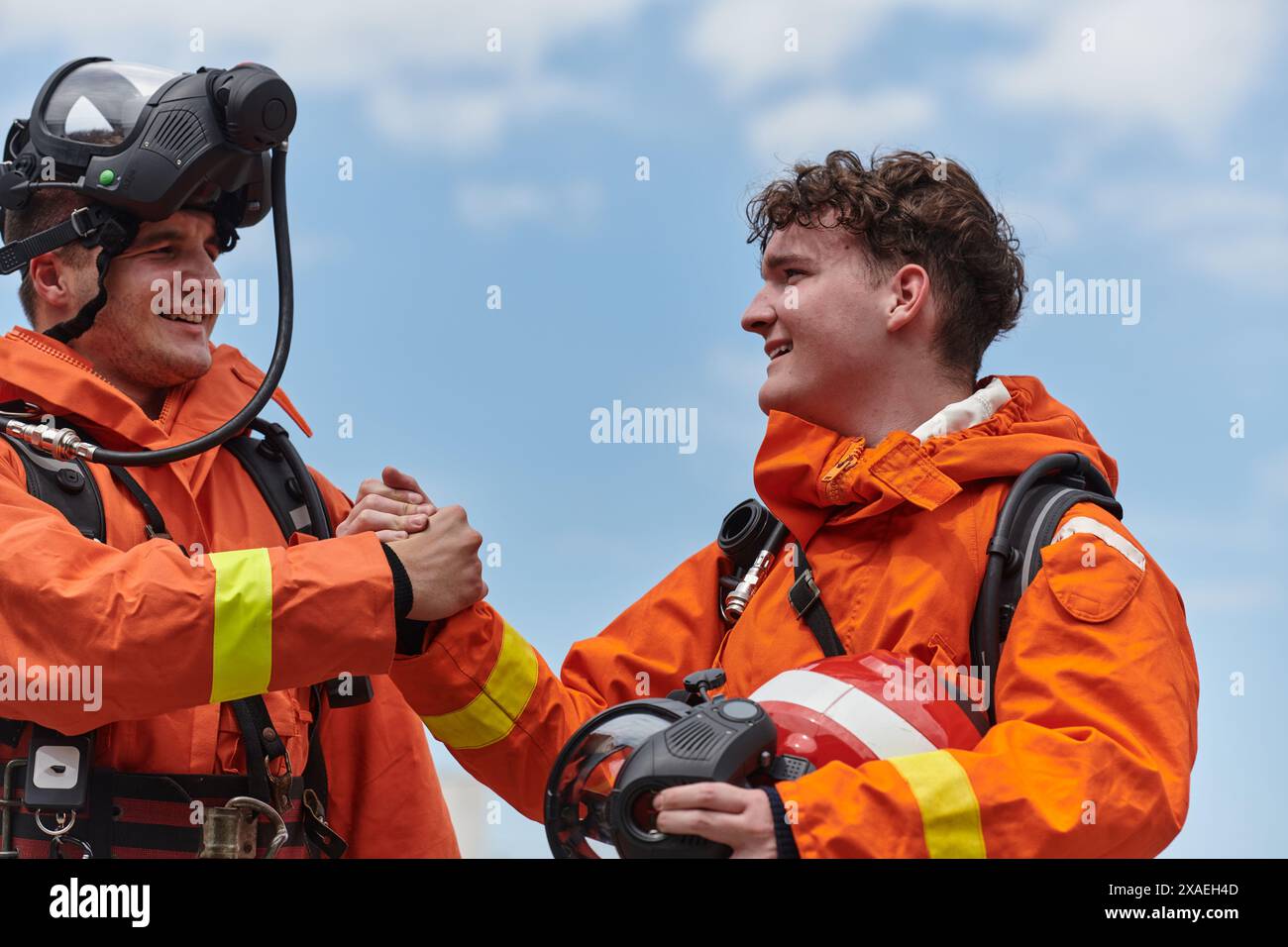 A unified team of firefighters, adorned in their uniforms, engages in a ...