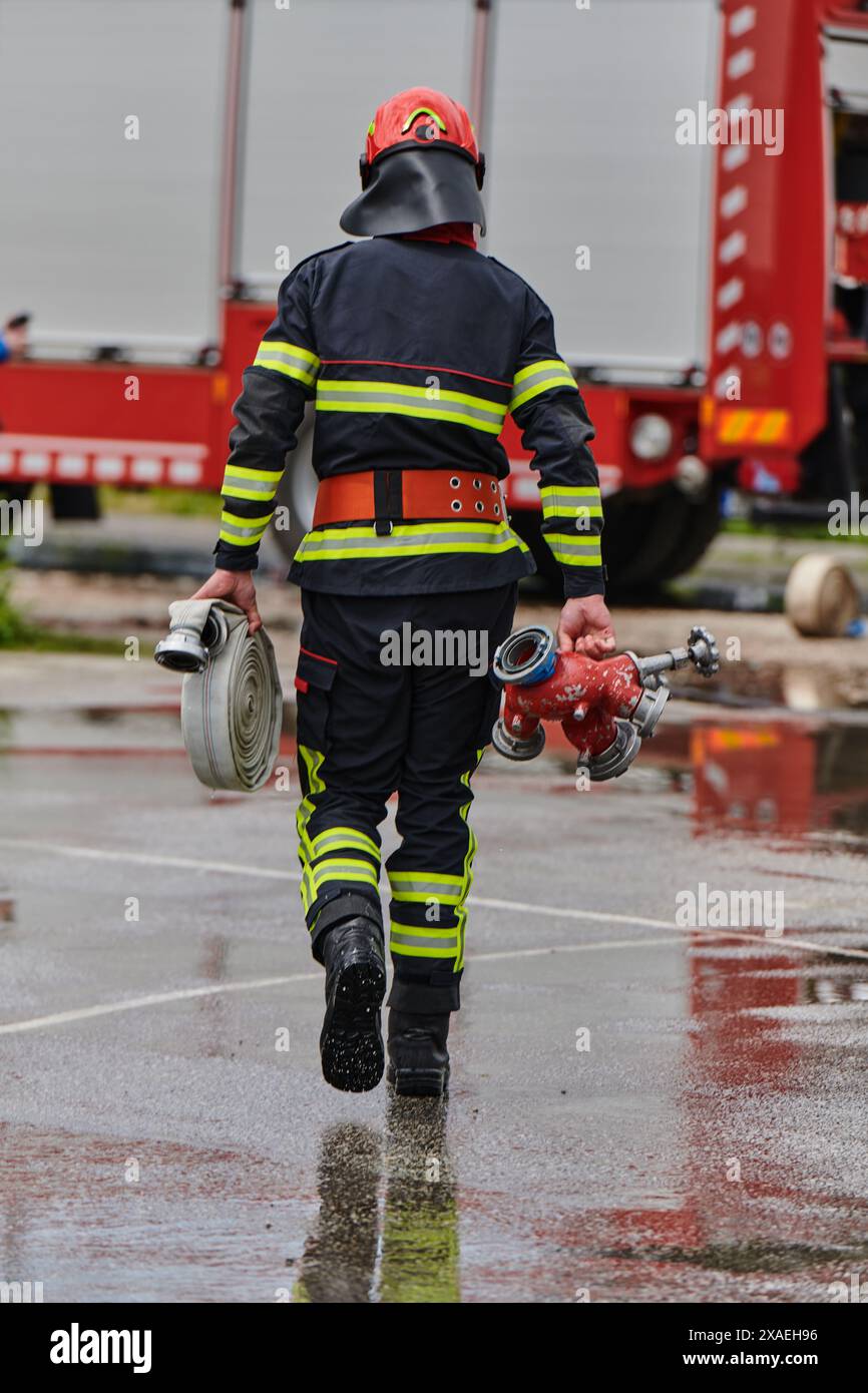 In a dynamic display of synchronized teamwork, firefighters hustle to ...