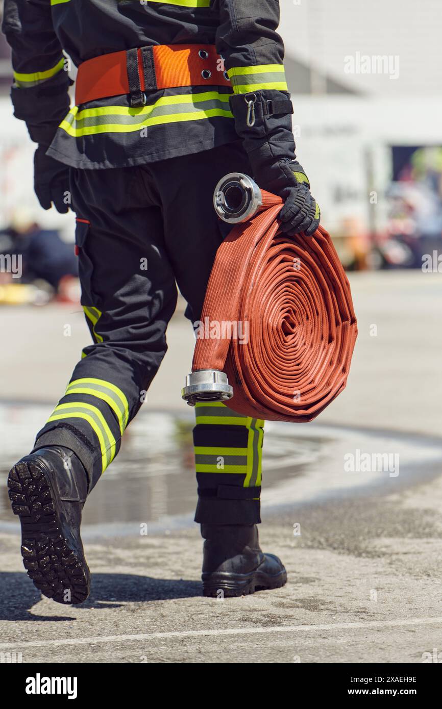 In a dynamic display of synchronized teamwork, firefighters hustle to ...