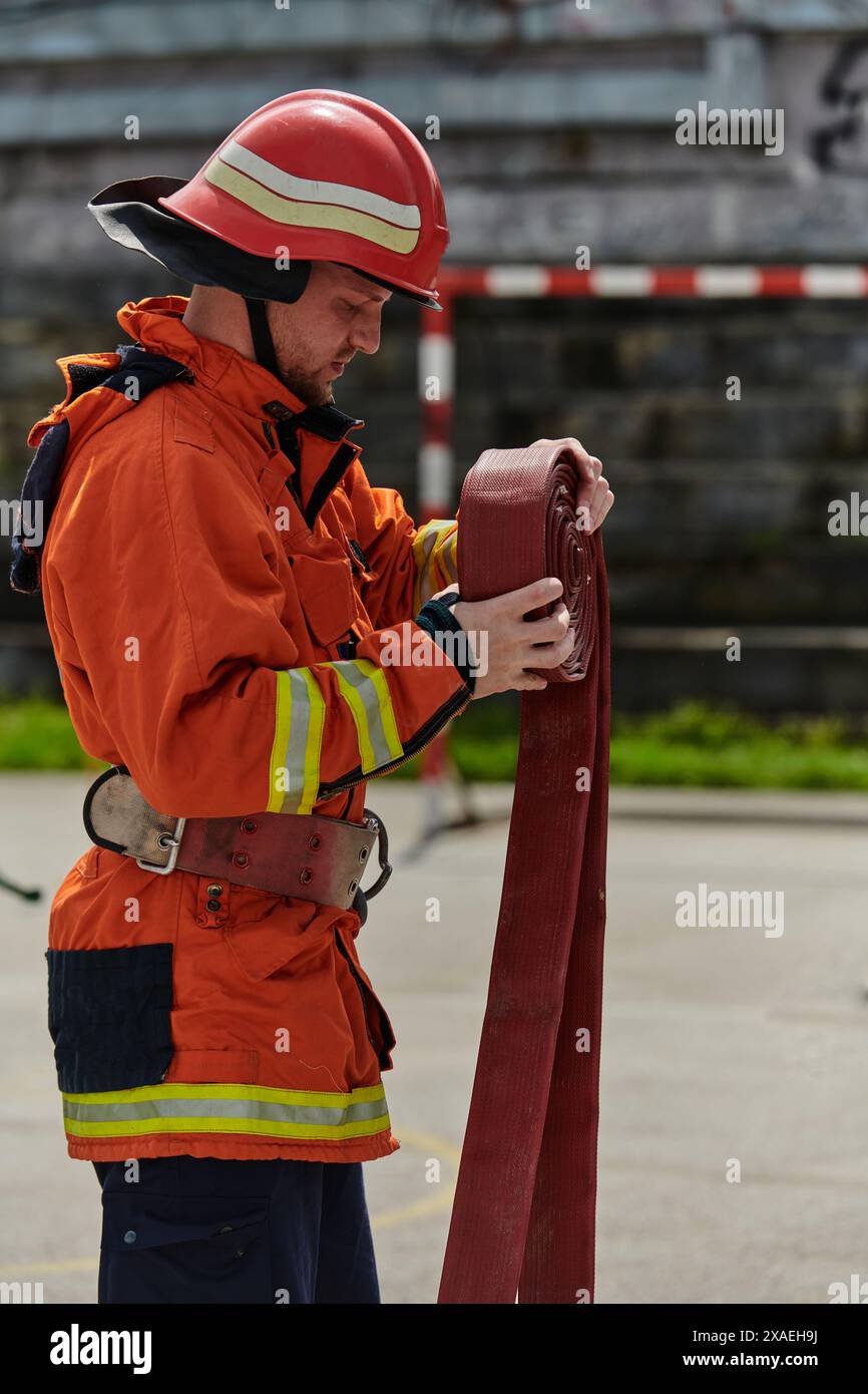 Professional Firefighter Cleaning Up Fire Hose After Extinguishing ...