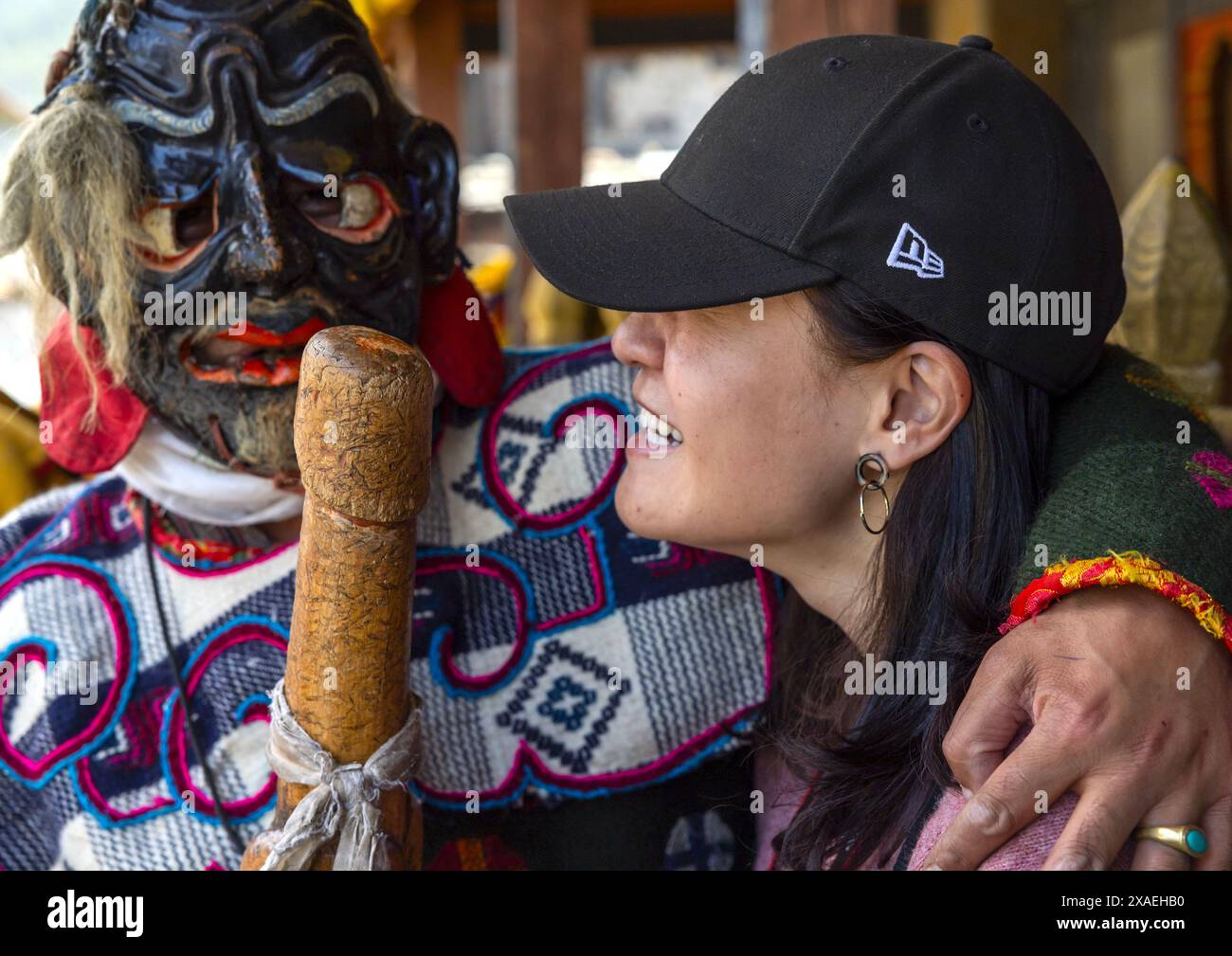 Atsara showing a wooden phallus to a tourist at the Ura Yakchoe ...