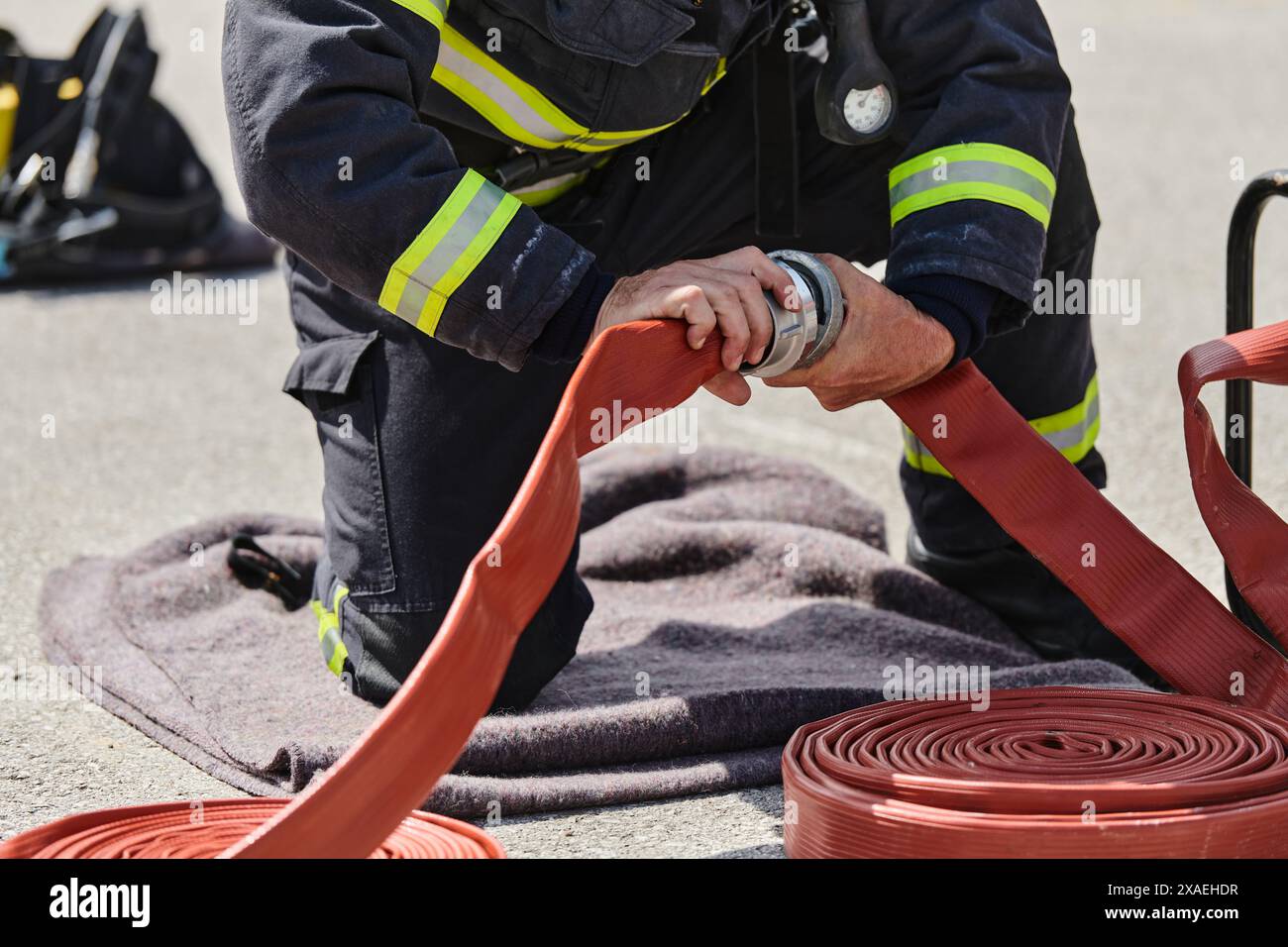 Professional Firefighter Cleaning Up Fire Hose After Extinguishing ...