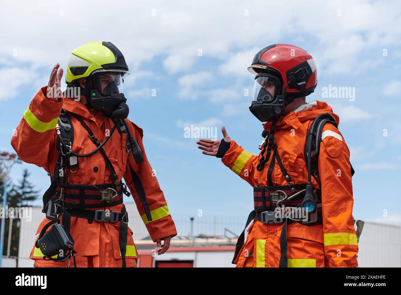 A unified team of firefighters, adorned in their uniforms, engages in a ...