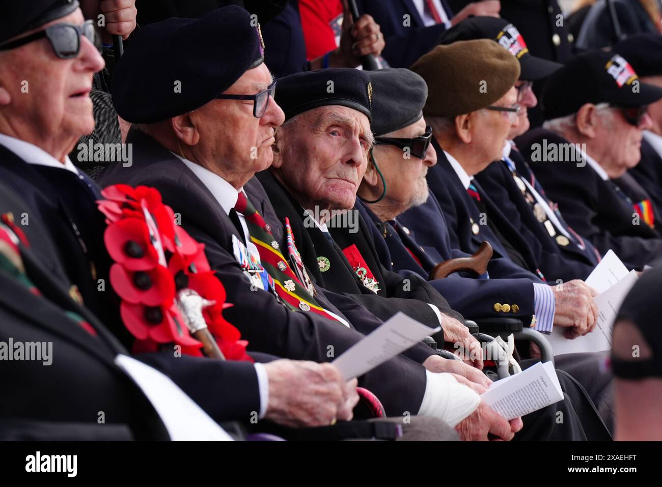 Veterans Ken Hay (second left) and John Dennett (centre) watch a parade ...