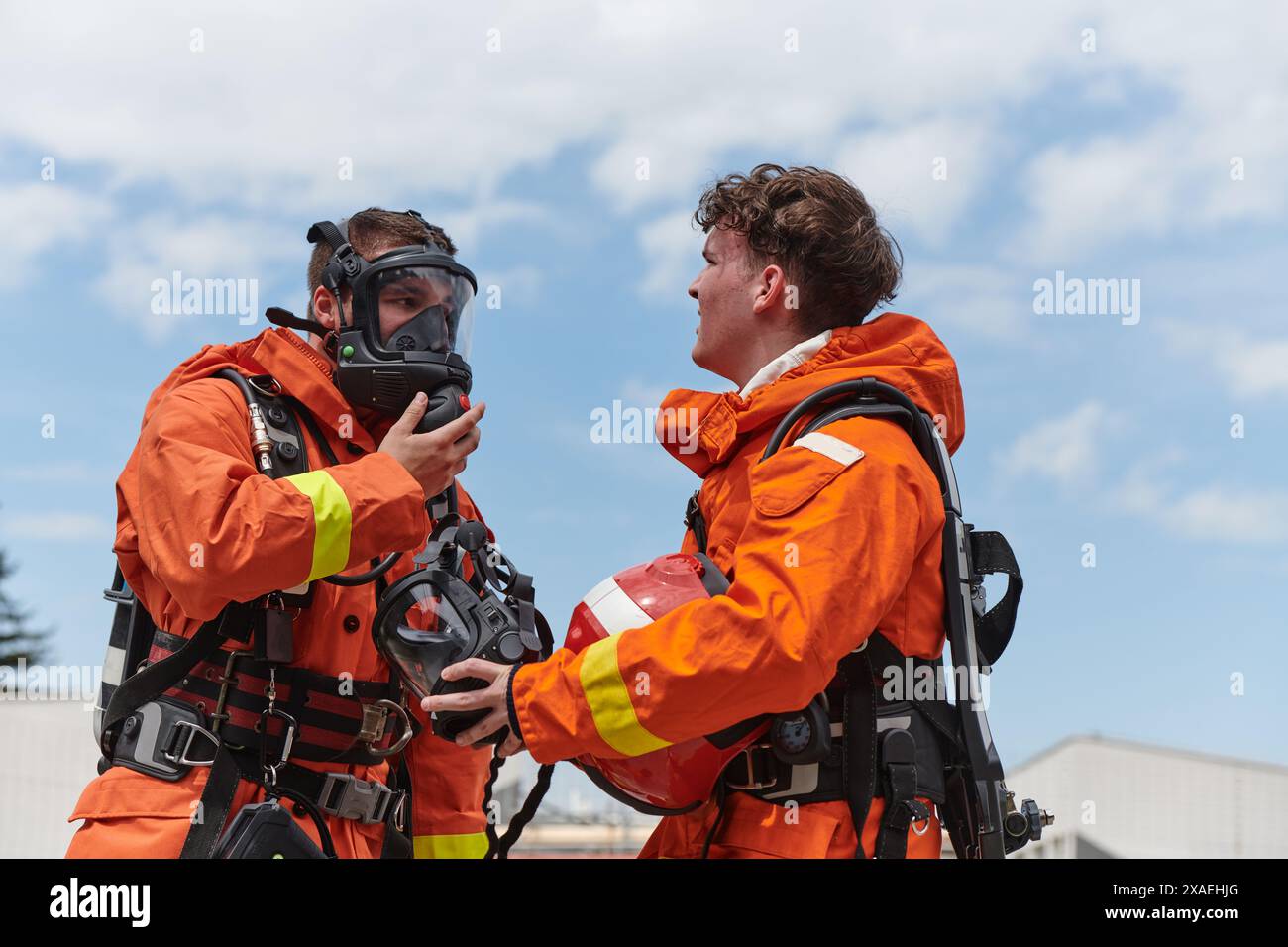 A unified team of firefighters, adorned in their uniforms, engages in a ...
