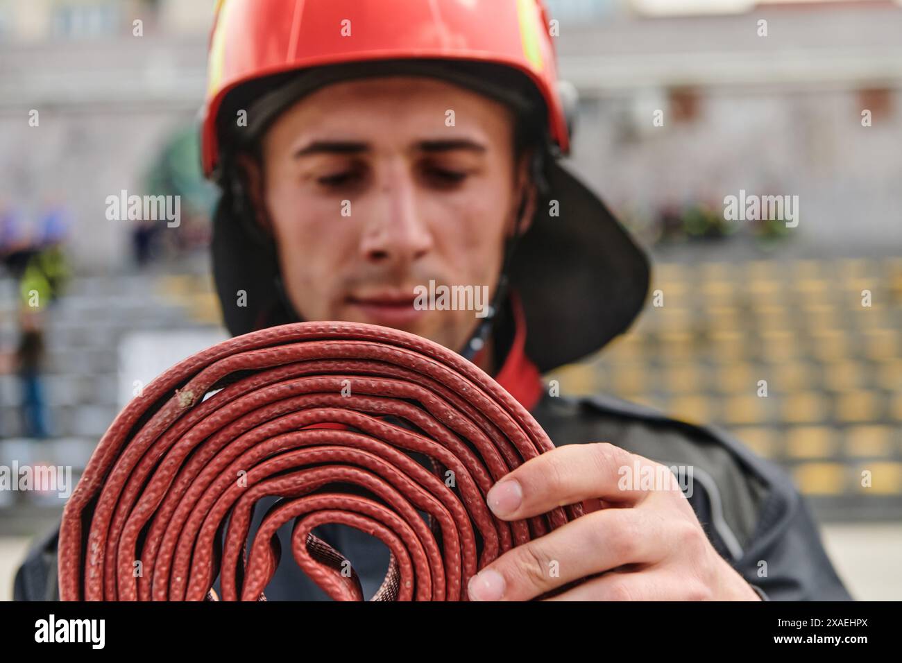 Professional Firefighter Cleaning Up Fire Hose After Extinguishing ...