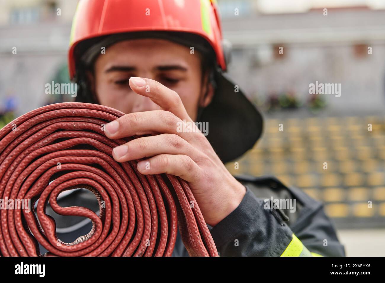 Professional Firefighter Cleaning Up Fire Hose After Extinguishing ...