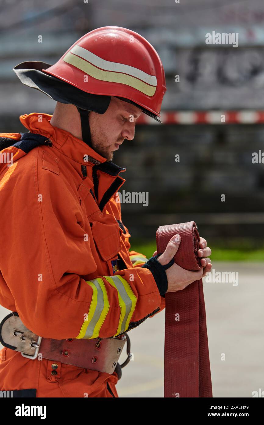 Professional Firefighter Cleaning Up Fire Hose After Extinguishing ...