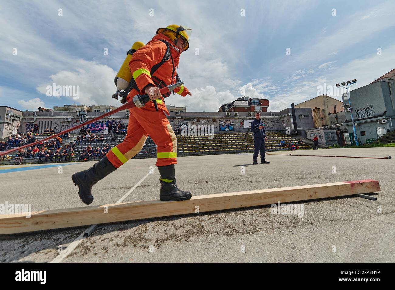 In a dynamic display of synchronized teamwork, firefighters hustle to ...