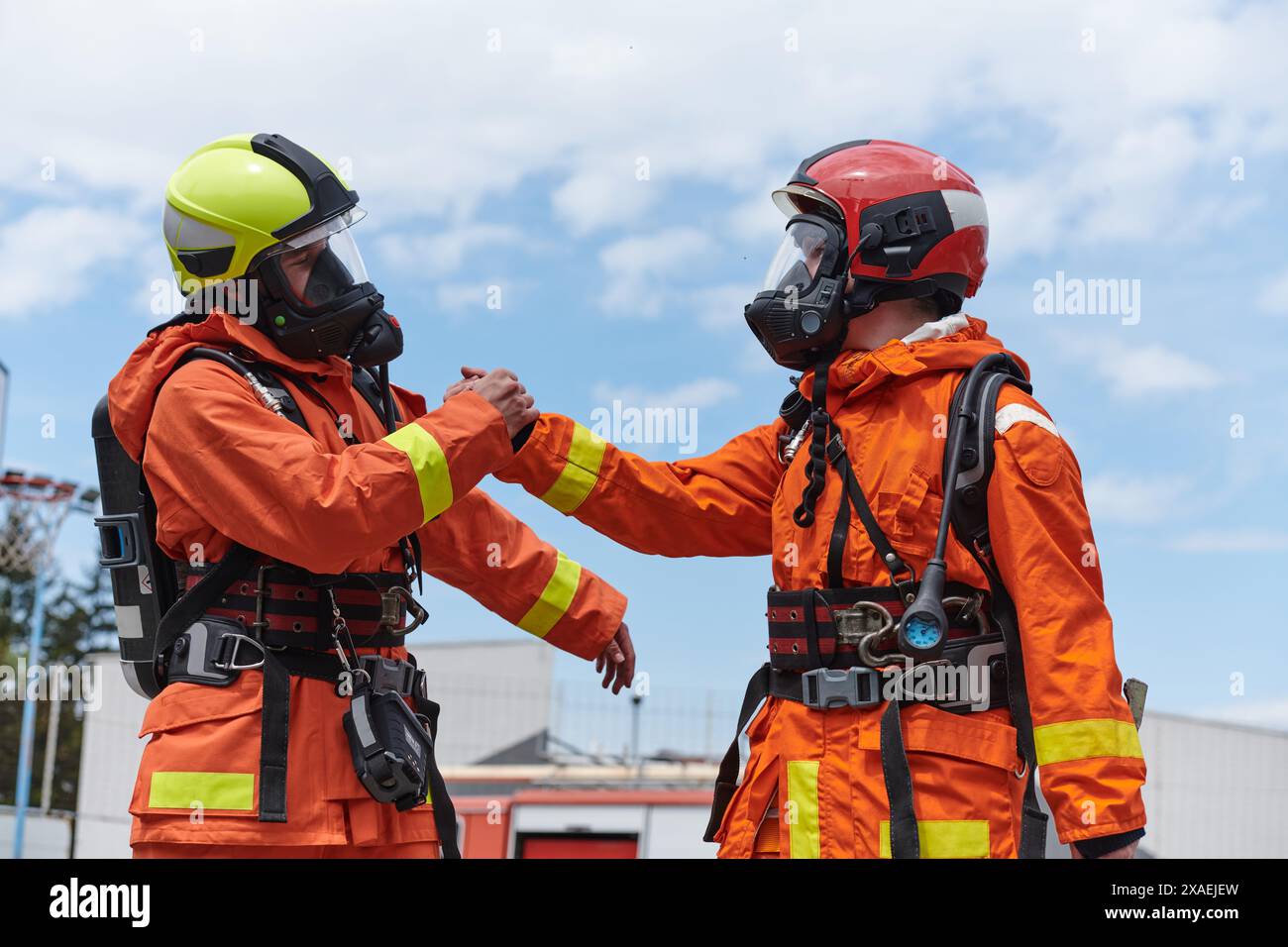 A unified team of firefighters, adorned in their uniforms, engages in a ...