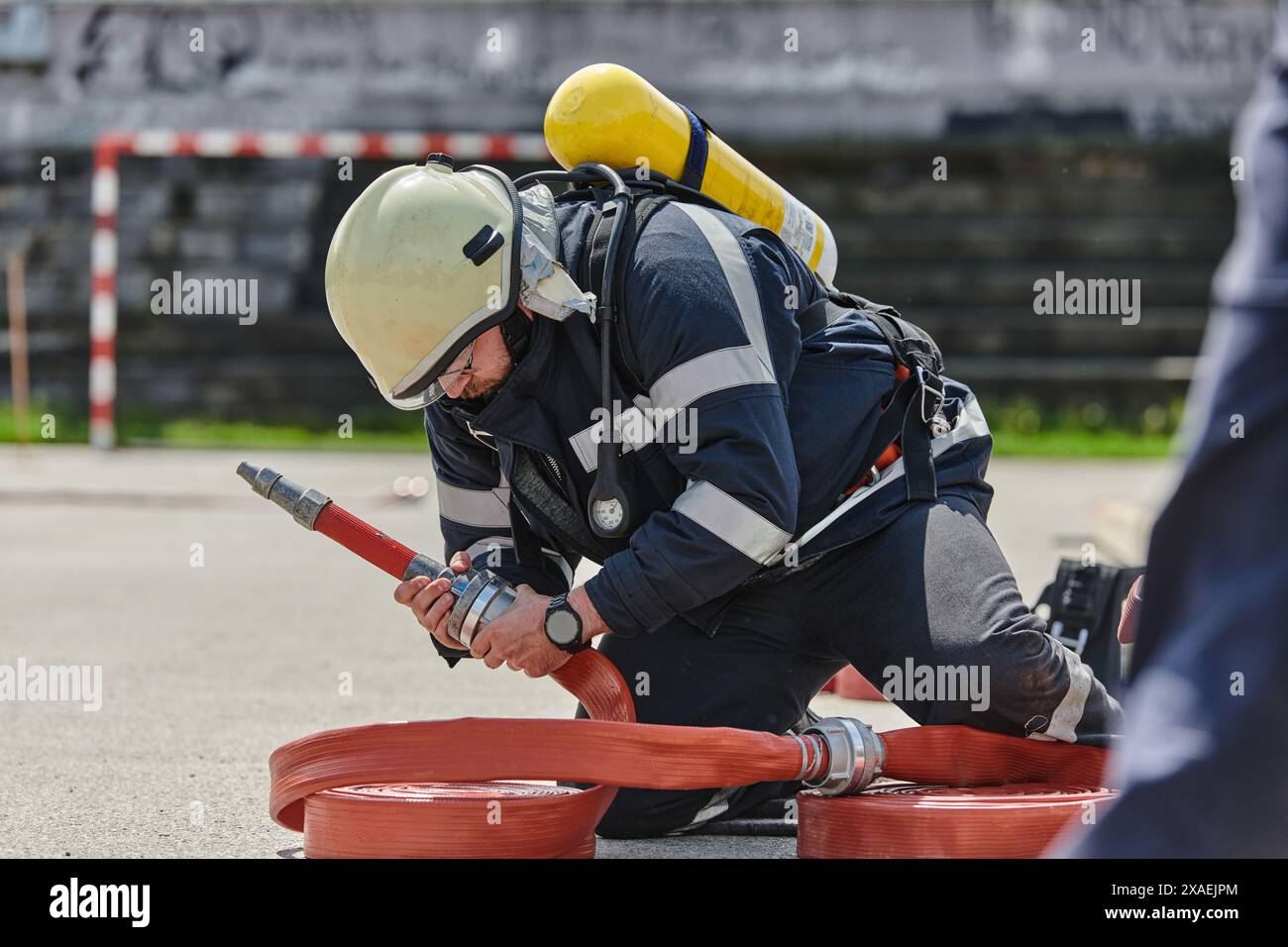 A firefighter dons the essential components of their professional gear ...