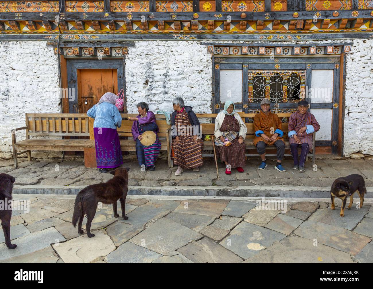 Old bhutanese people resting on bench in Jamphel Lhakhang, Chhoekhor ...