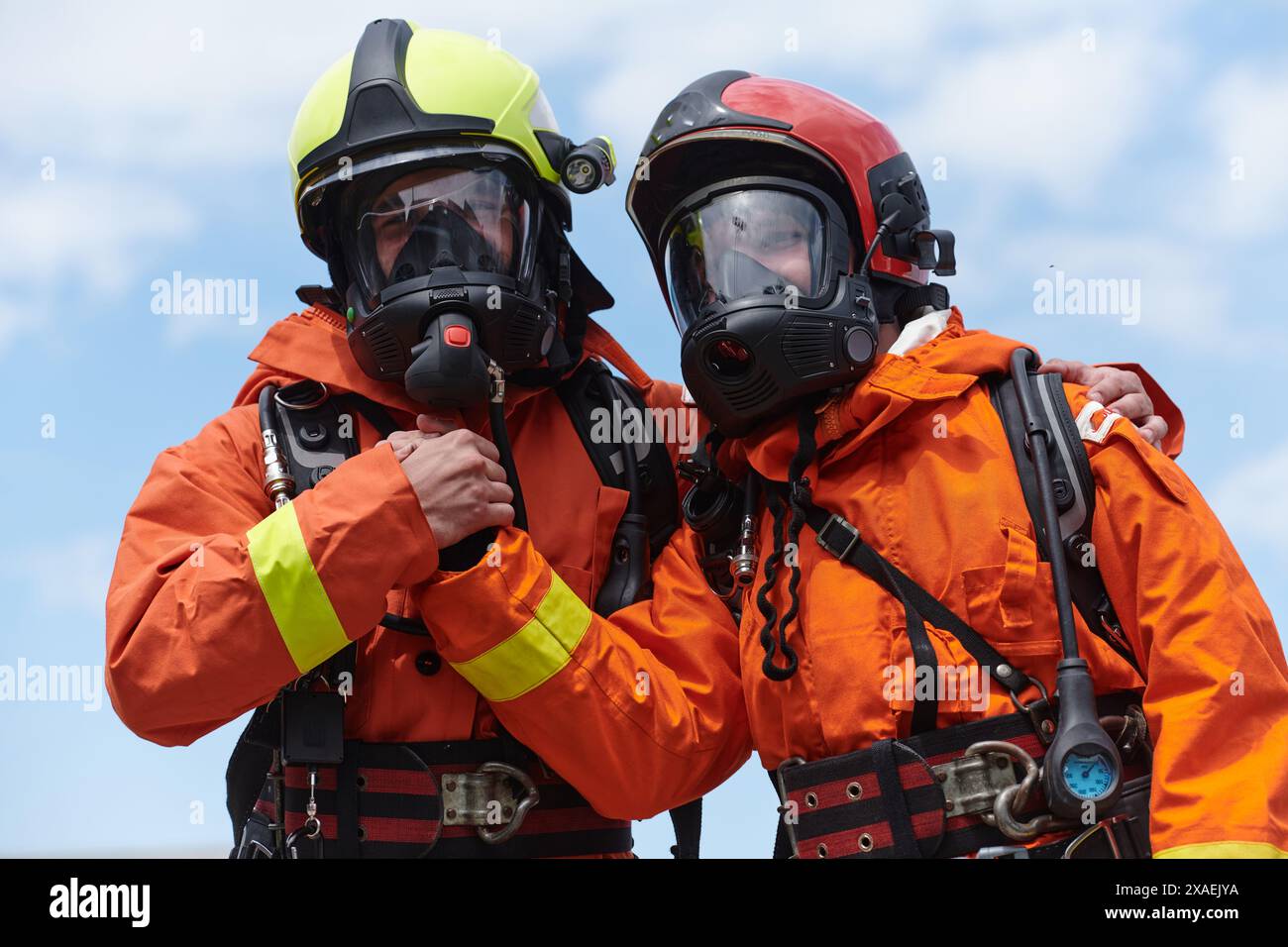 A unified team of firefighters, adorned in their uniforms, engages in a ...