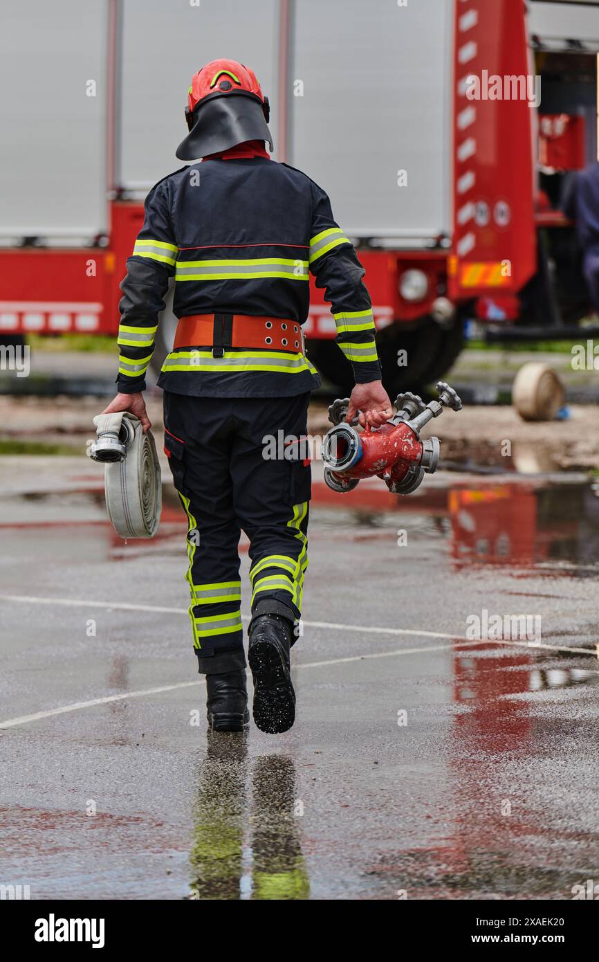 In a dynamic display of synchronized teamwork, firefighters hustle to ...
