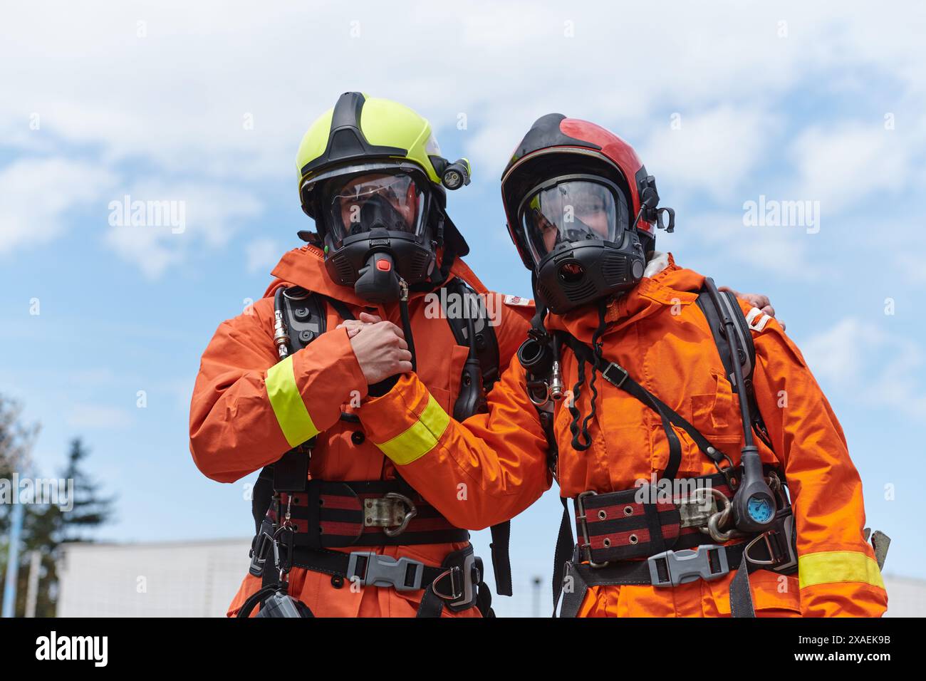 A unified team of firefighters, adorned in their uniforms, engages in a ...
