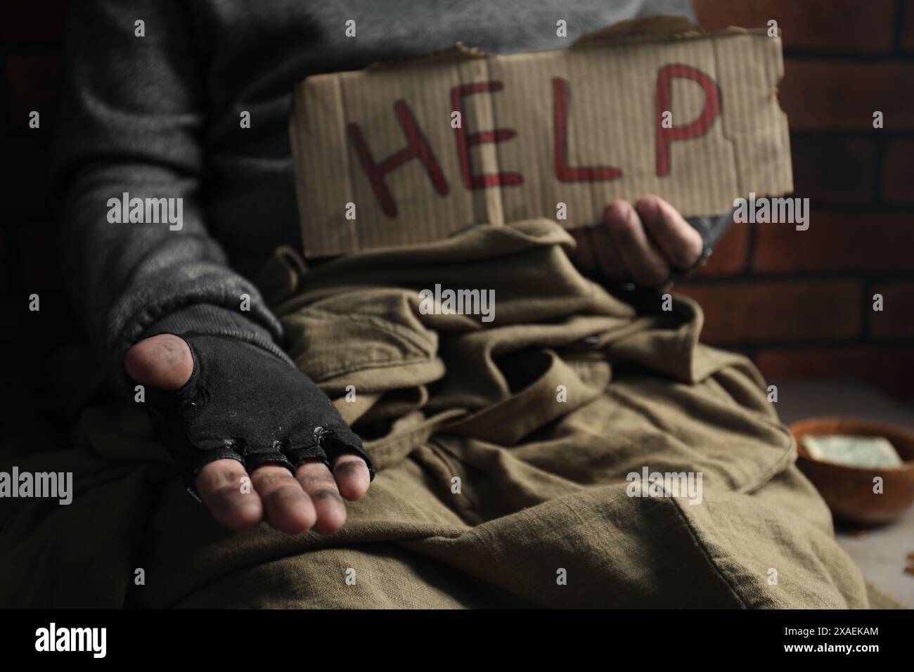 Poor homeless man with help sign begging for money, closeup. Charity ...