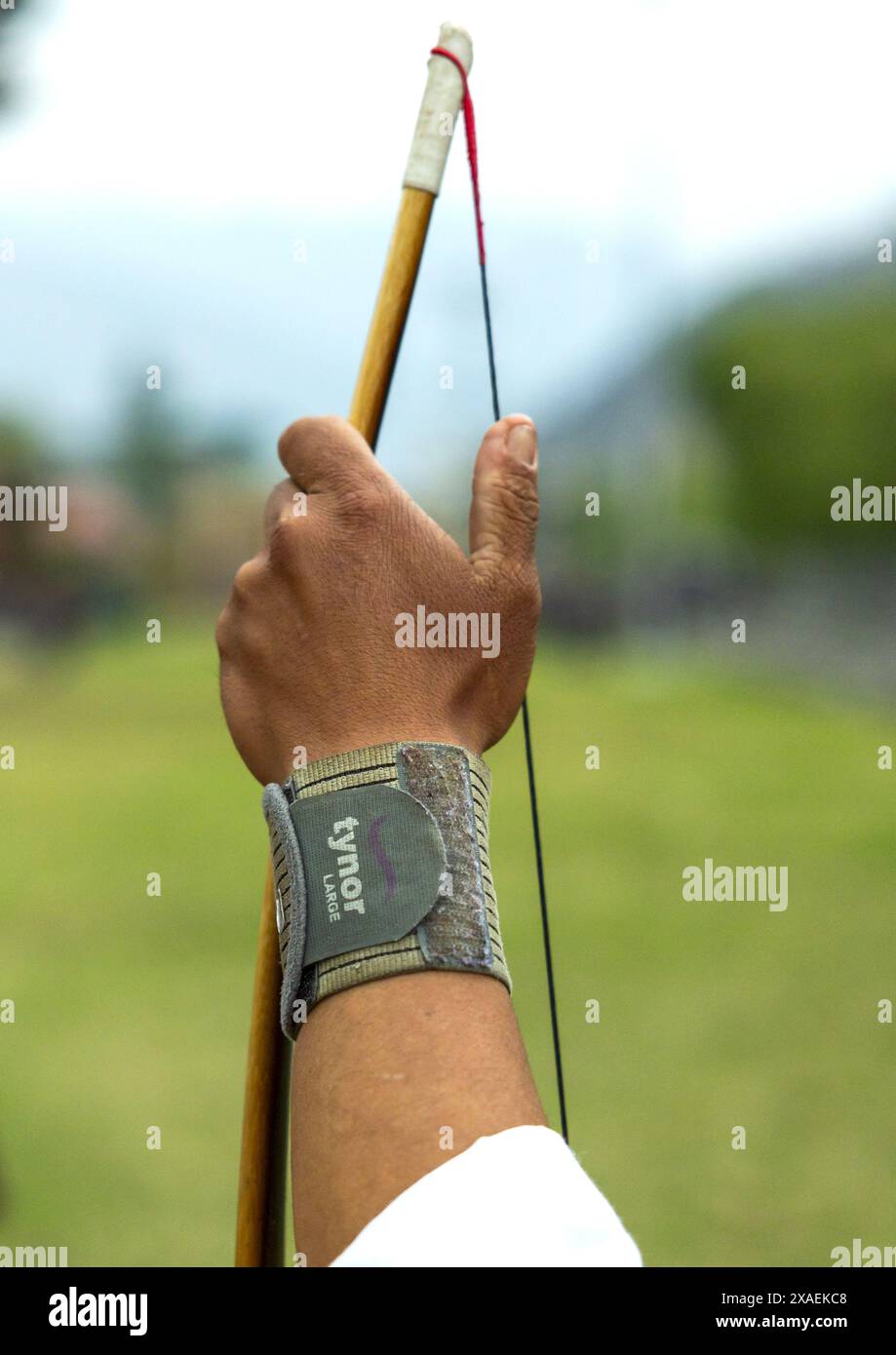 Bhutanese archer hand on an archery range, Chang Gewog, Thimphu, Bhutan ...