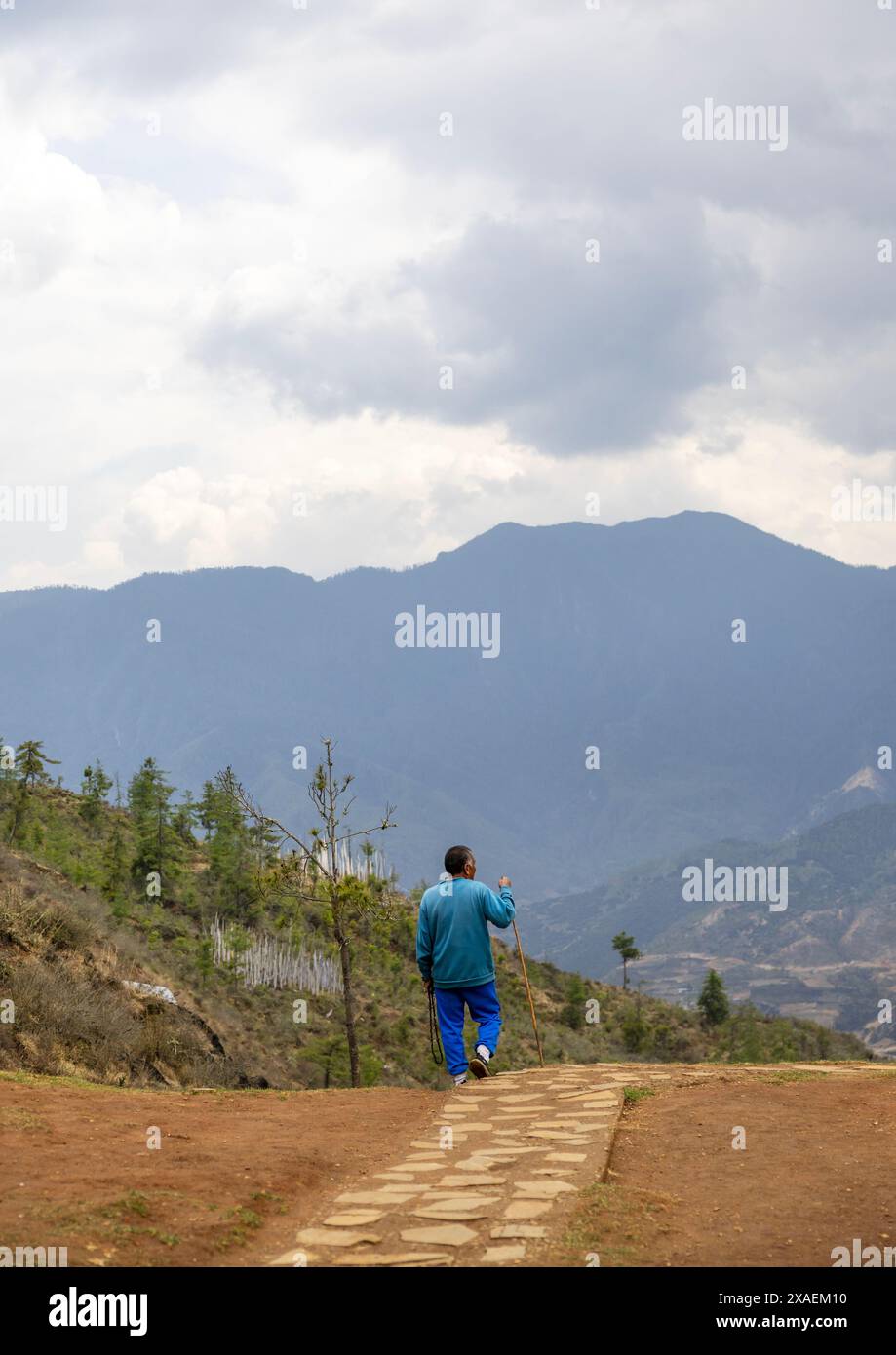 Bhutanese man hiking in the mountain, Paro, Drakarpo, Bhutan Stock ...