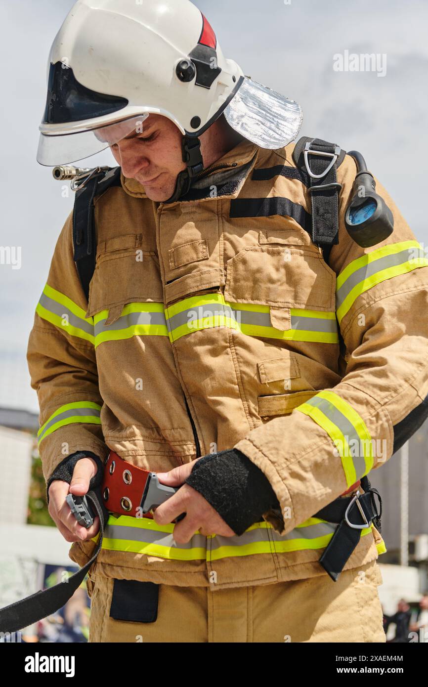 A firefighter dons the essential components of their professional gear ...
