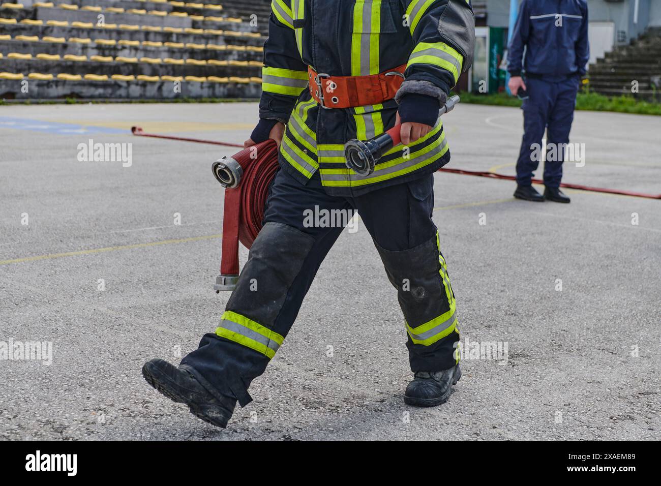 A firefighter dons the essential components of their professional gear ...