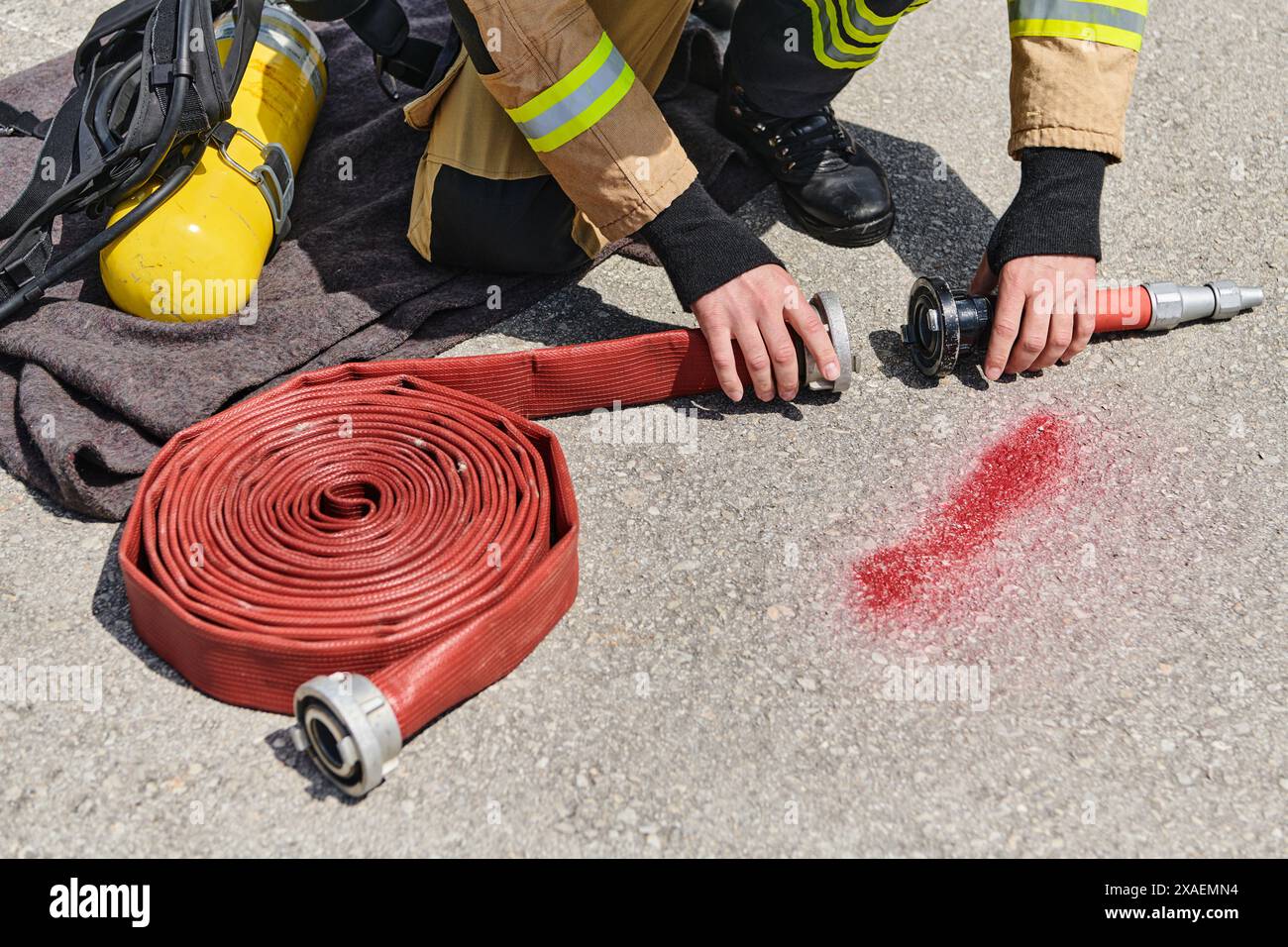 Professional Firefighter Cleaning Up Fire Hose After Extinguishing ...