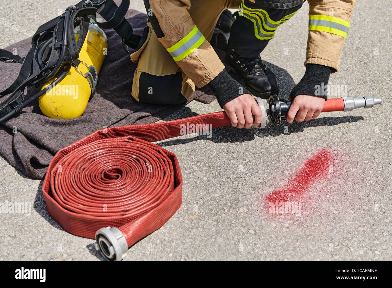 Professional Firefighter Cleaning Up Fire Hose After Extinguishing ...