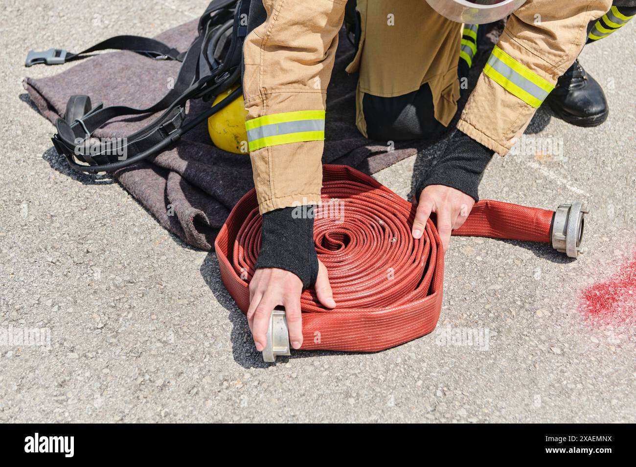 Professional Firefighter Cleaning Up Fire Hose After Extinguishing ...