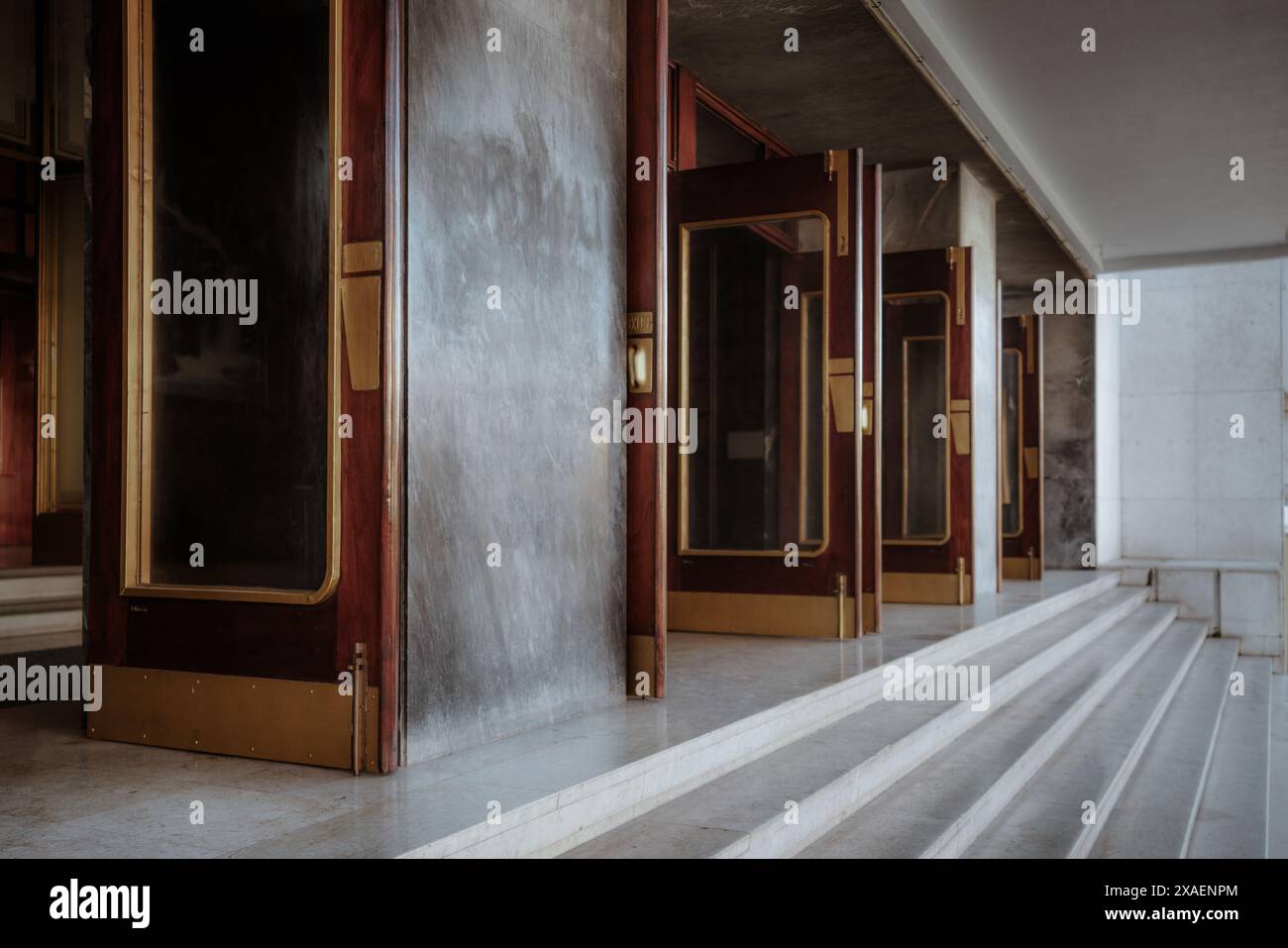 A close-up view of an elegant entrance with multiple wooden glass doors ...