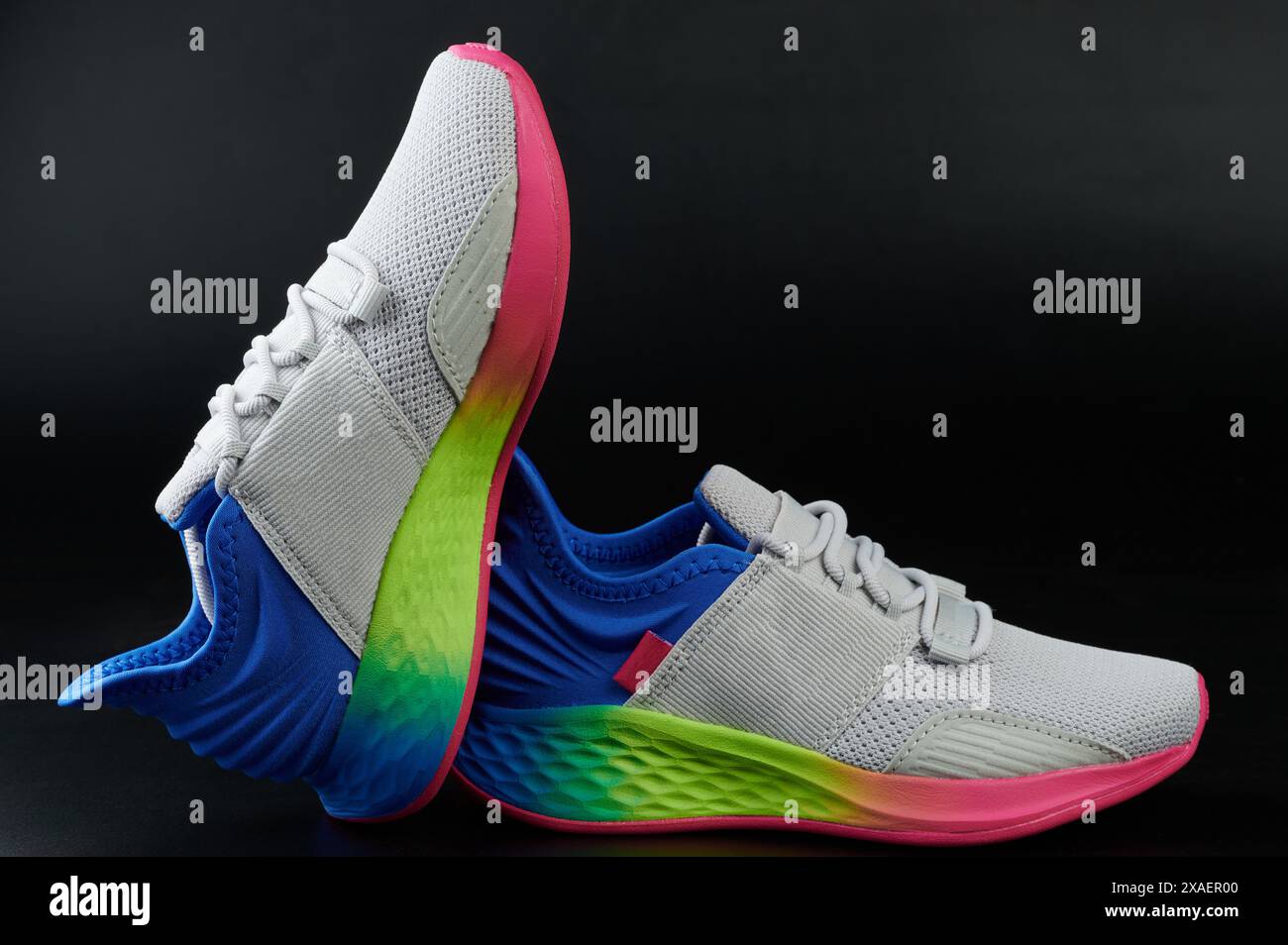 Pair of colorful sport shoes side view isolated on black background ...