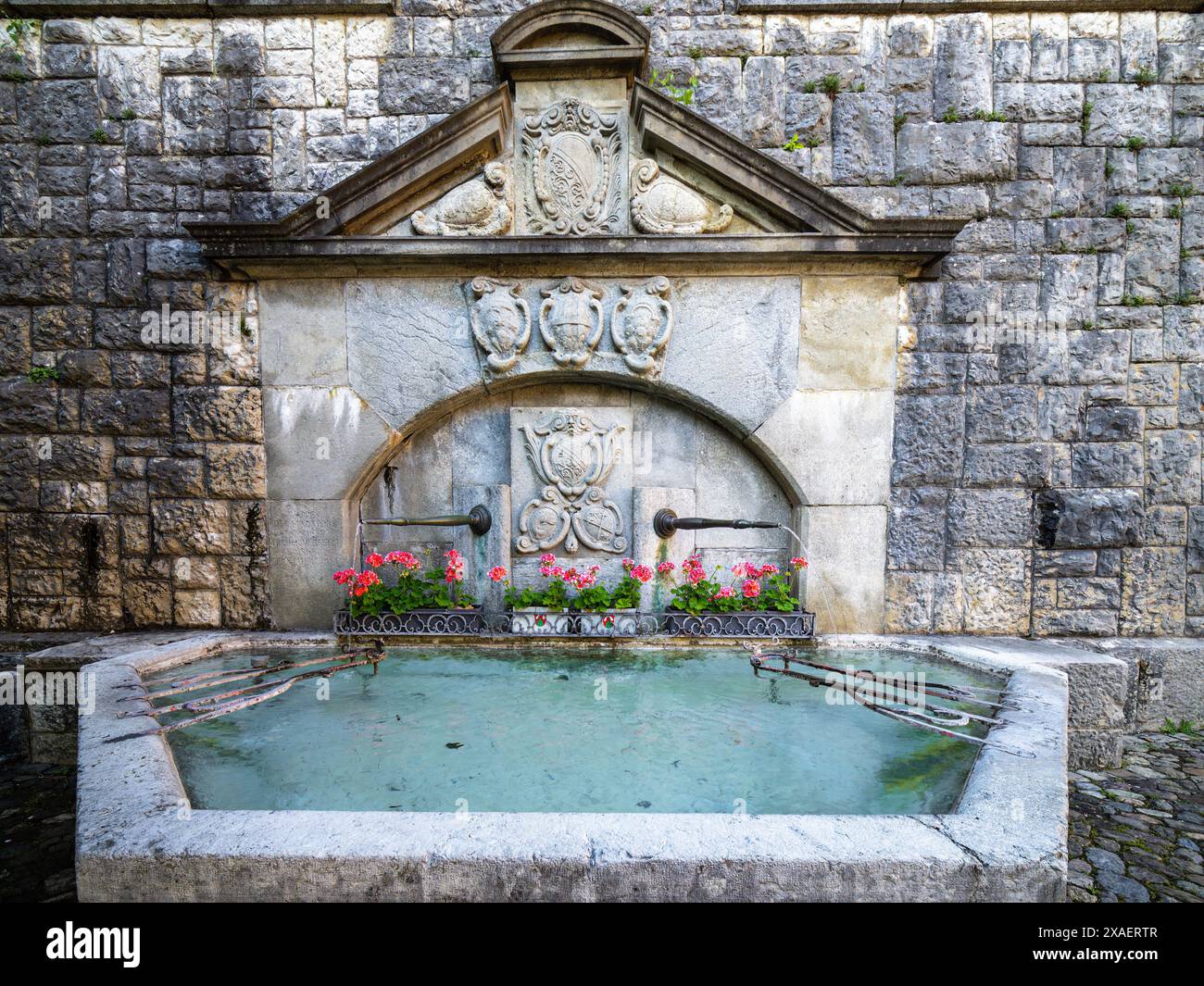 Historical stone fountain in Regensberg, Switzerland, against a ...