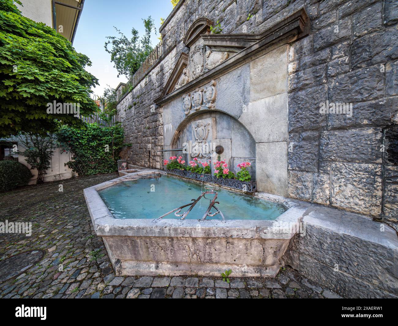 Historical stone fountain in Regensberg, Switzerland, against a ...