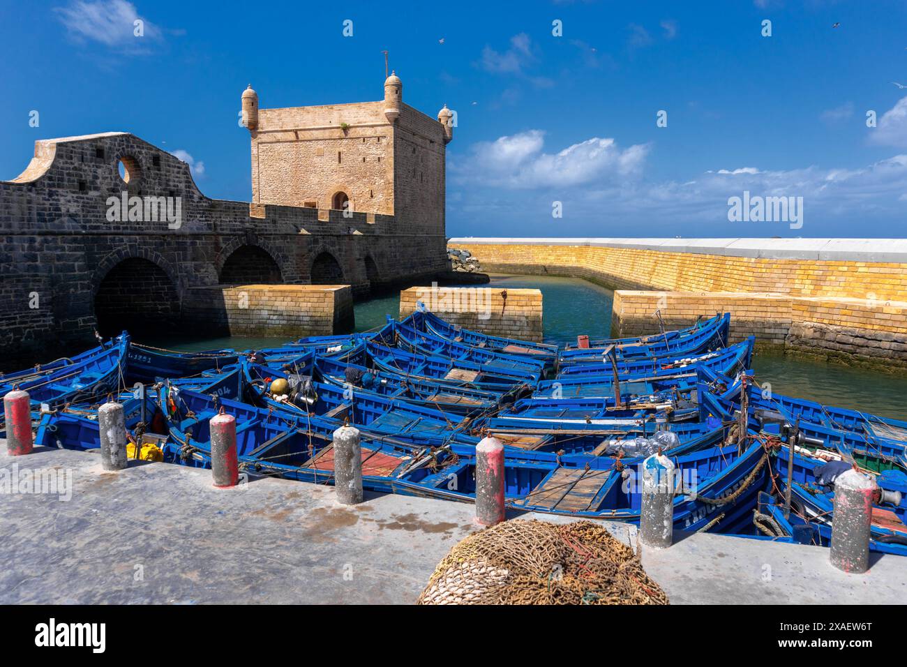 Essaouira, Morocco - 26 March, 2024: the Borj el Barmil watchtower and colourful blue fishing ...