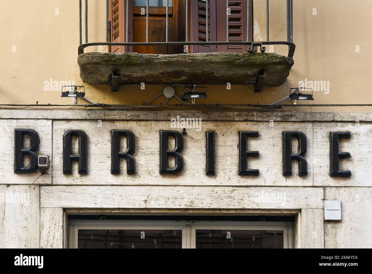Weathered barber shop sign ("barbiere" in Italian) on the facade of an ...