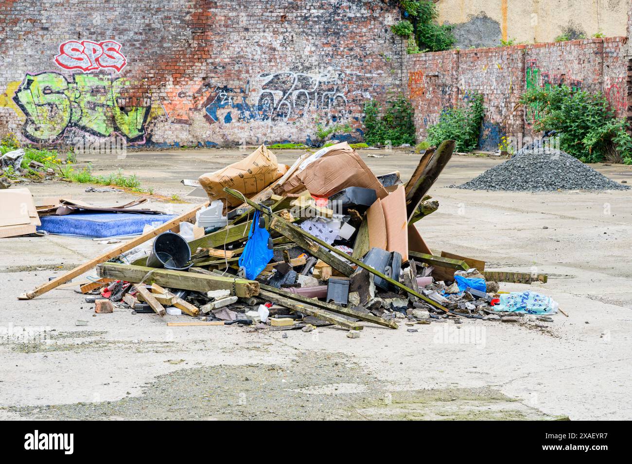 Rubbish piled up on a concrete yard Stock Photo - Alamy