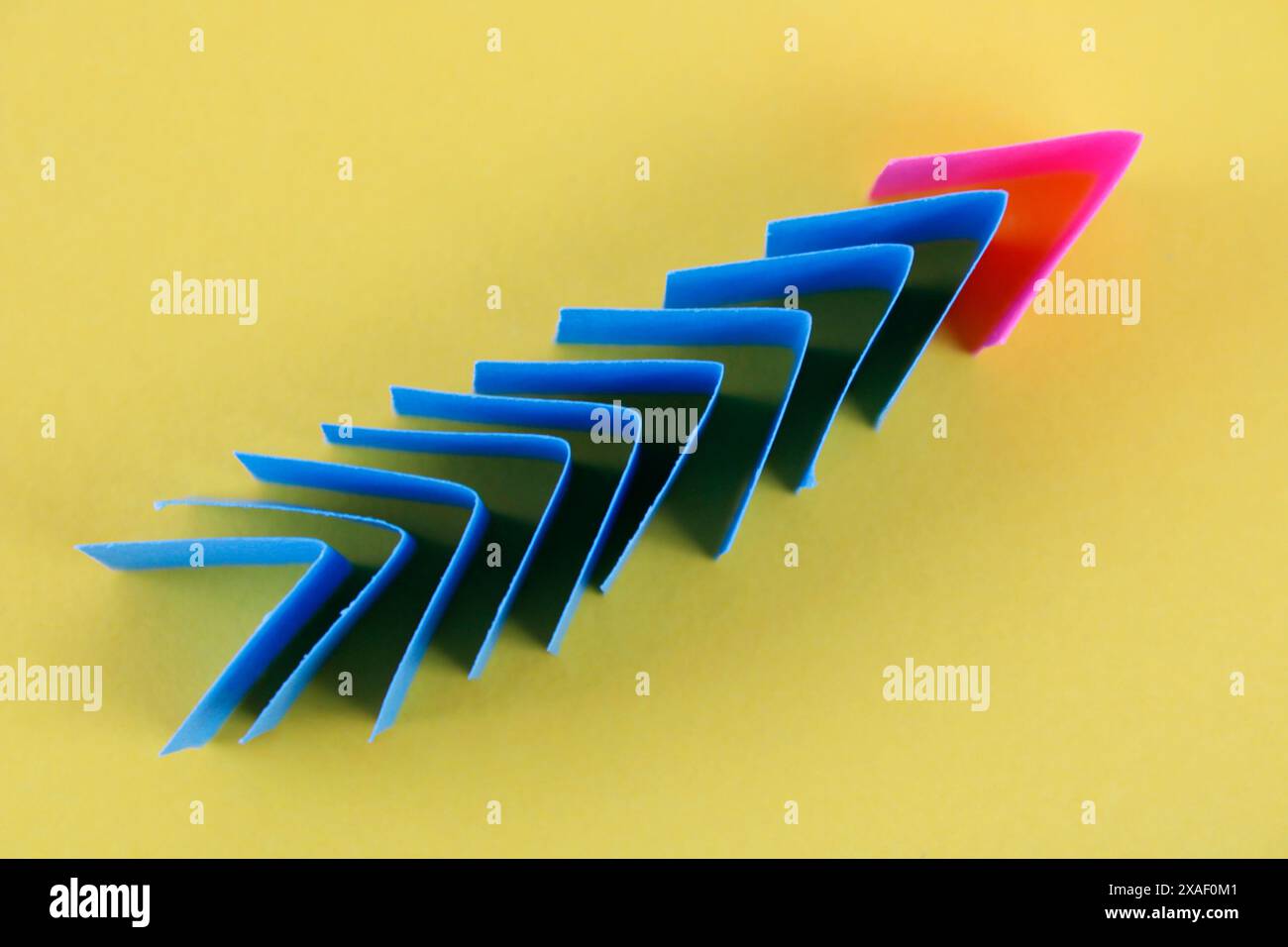 Papers folded to form an arrow and where one of them is differentiated ...