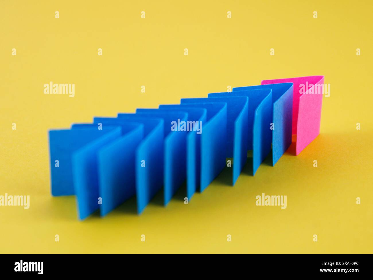 Folded papers formed in a row where one of them is differentiated by ...