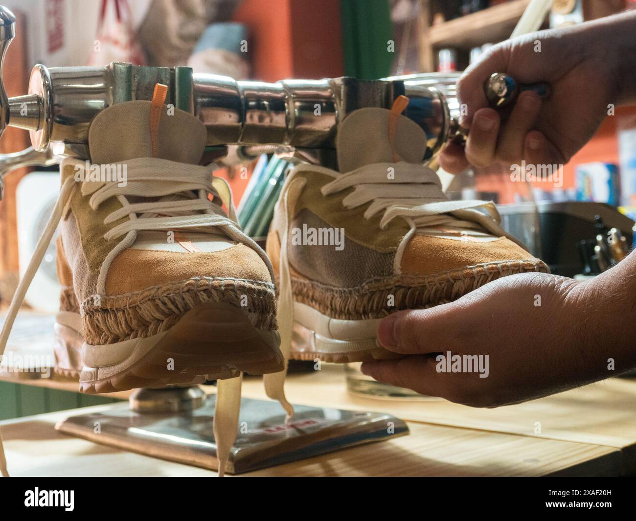 Shoemaker's hands placing shoes on lasts to take proper shape. Trades ...