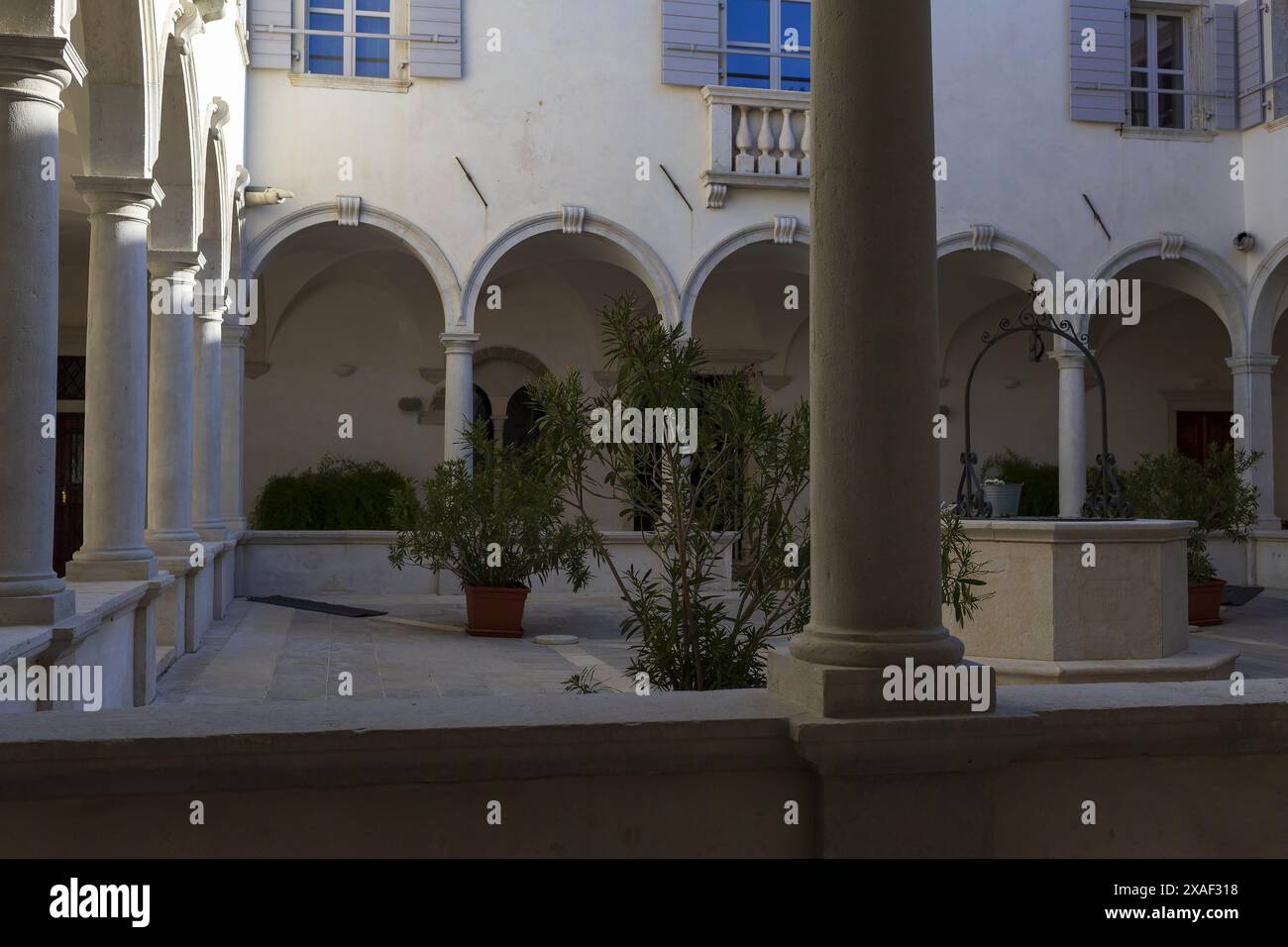 photo of an inner courtyard of white baroque building with columns ...