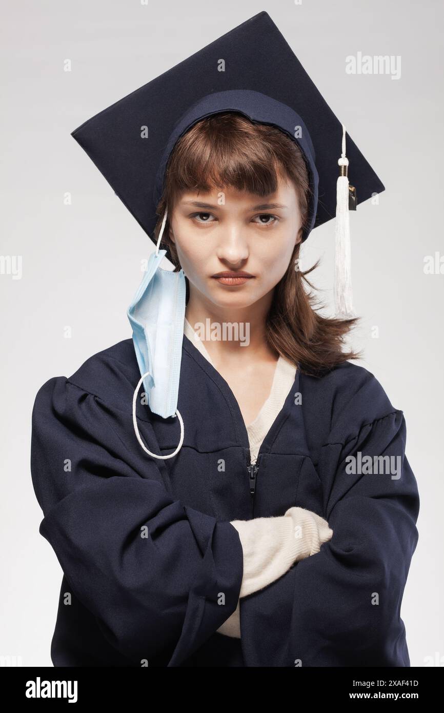 Graduation girl wearing gown and cap. Female student wearing protective ...