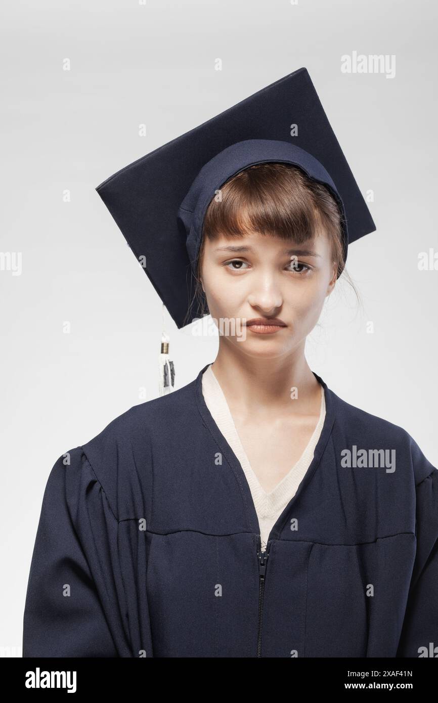 Graduation student portrait isolated on white background. Sad girl ...