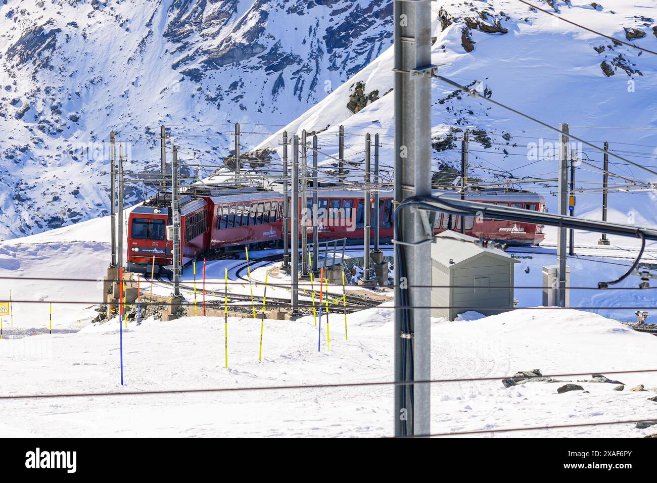 Cogwheel train of the Gornergrat Railway riding on a rack rail above ...