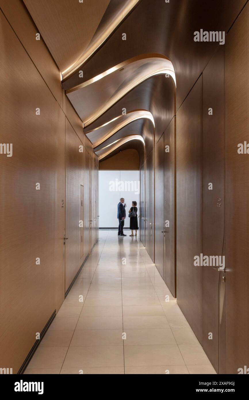 Interior corridor with figures standing at the end. BEEAH Headquarters ...