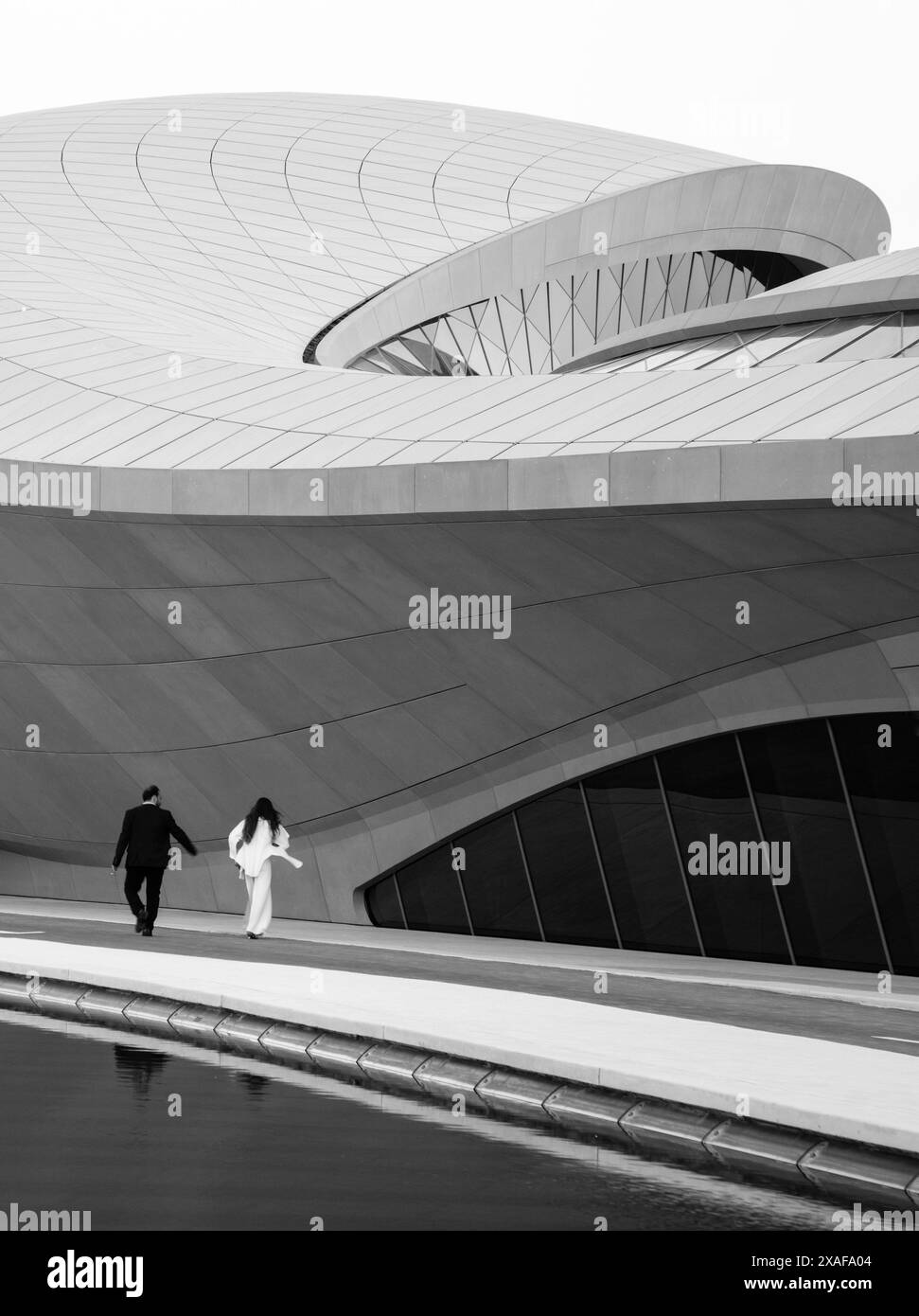 Two people heading towards the main entrance. BEEAH Headquarters ...