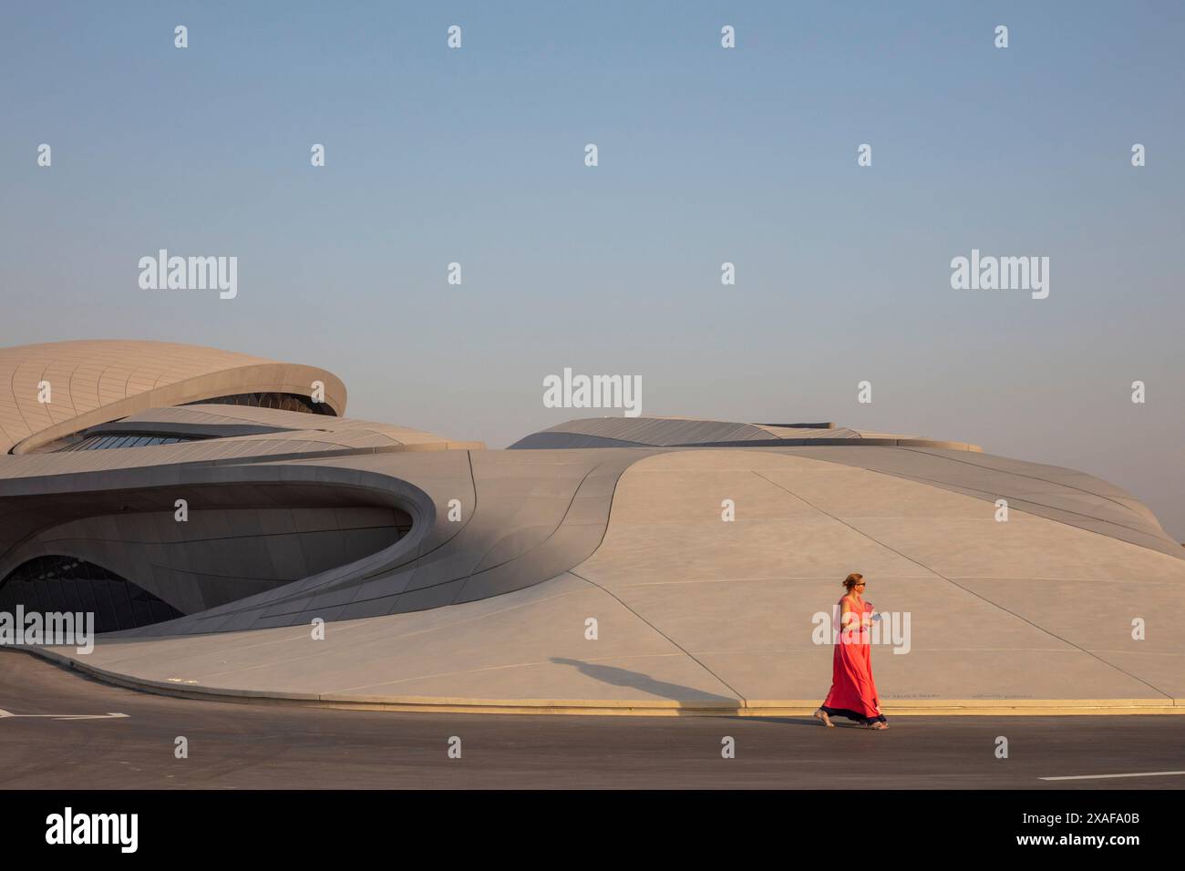 Someone walking passed the end of the building with some low sun ...